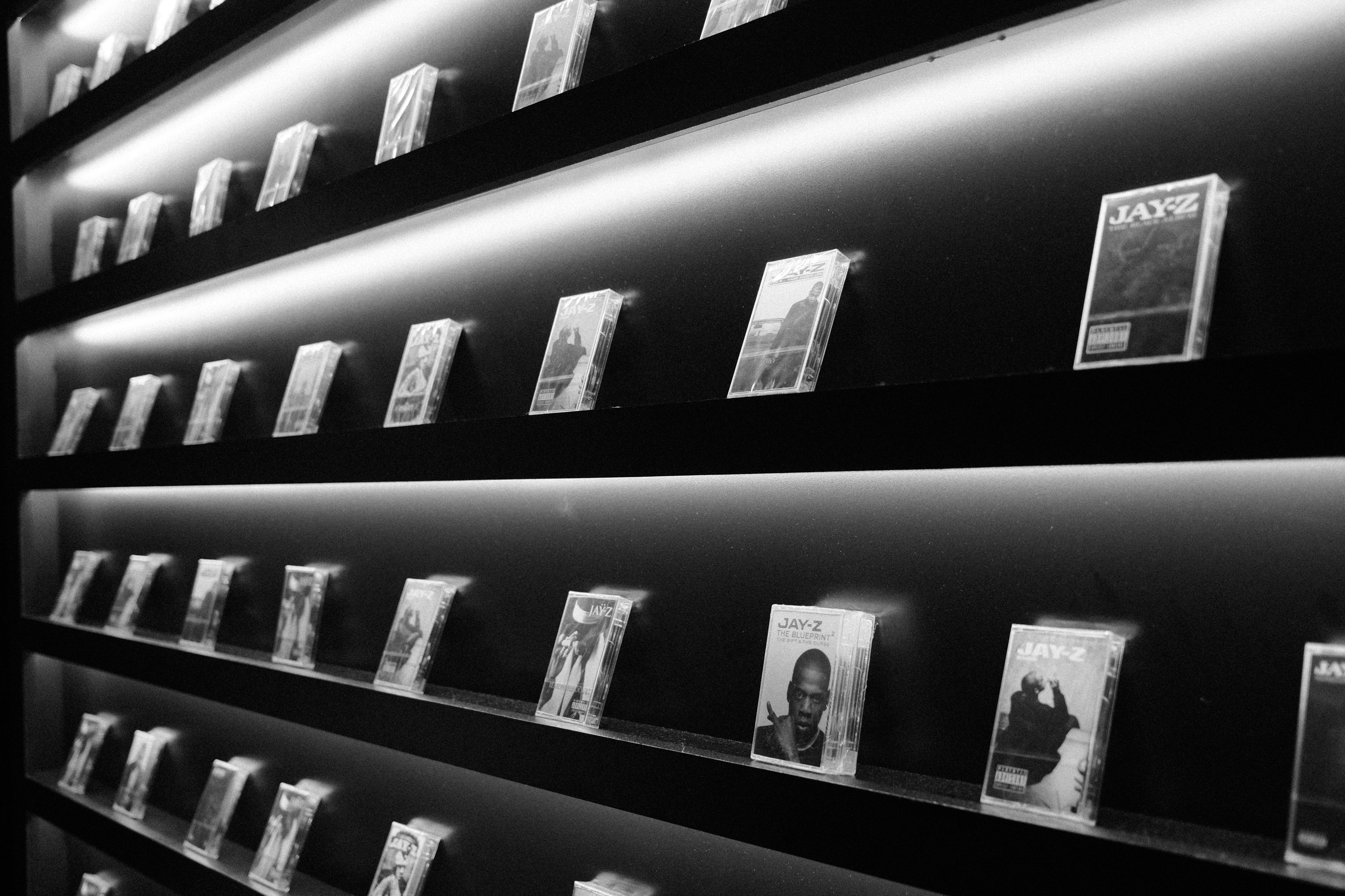 Monochrome Gallery: Rows of Business Cards on Softly Lit Shelves