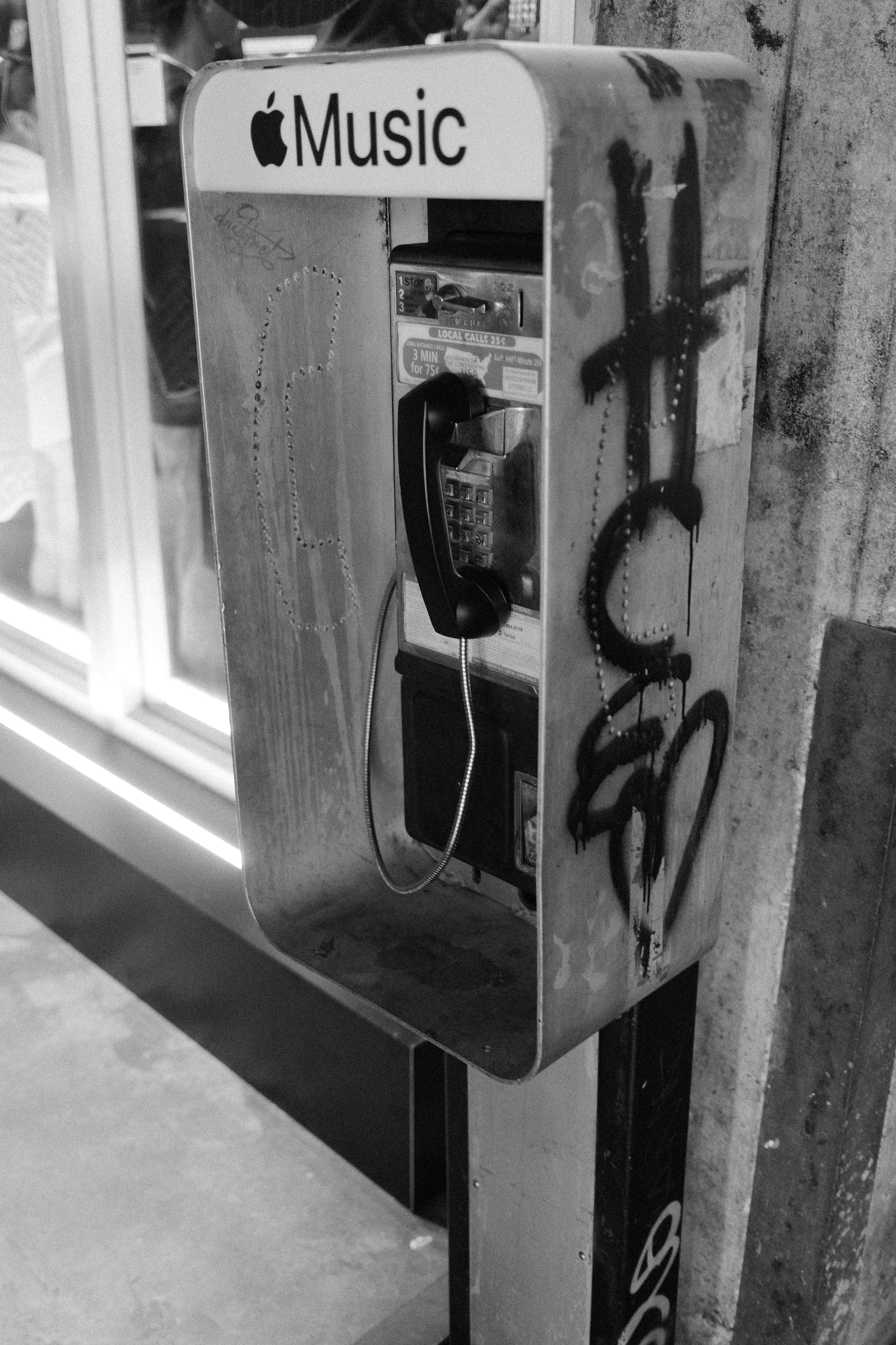 Graffiti-Soaked Apple Music Kiosk Emerges from the Street