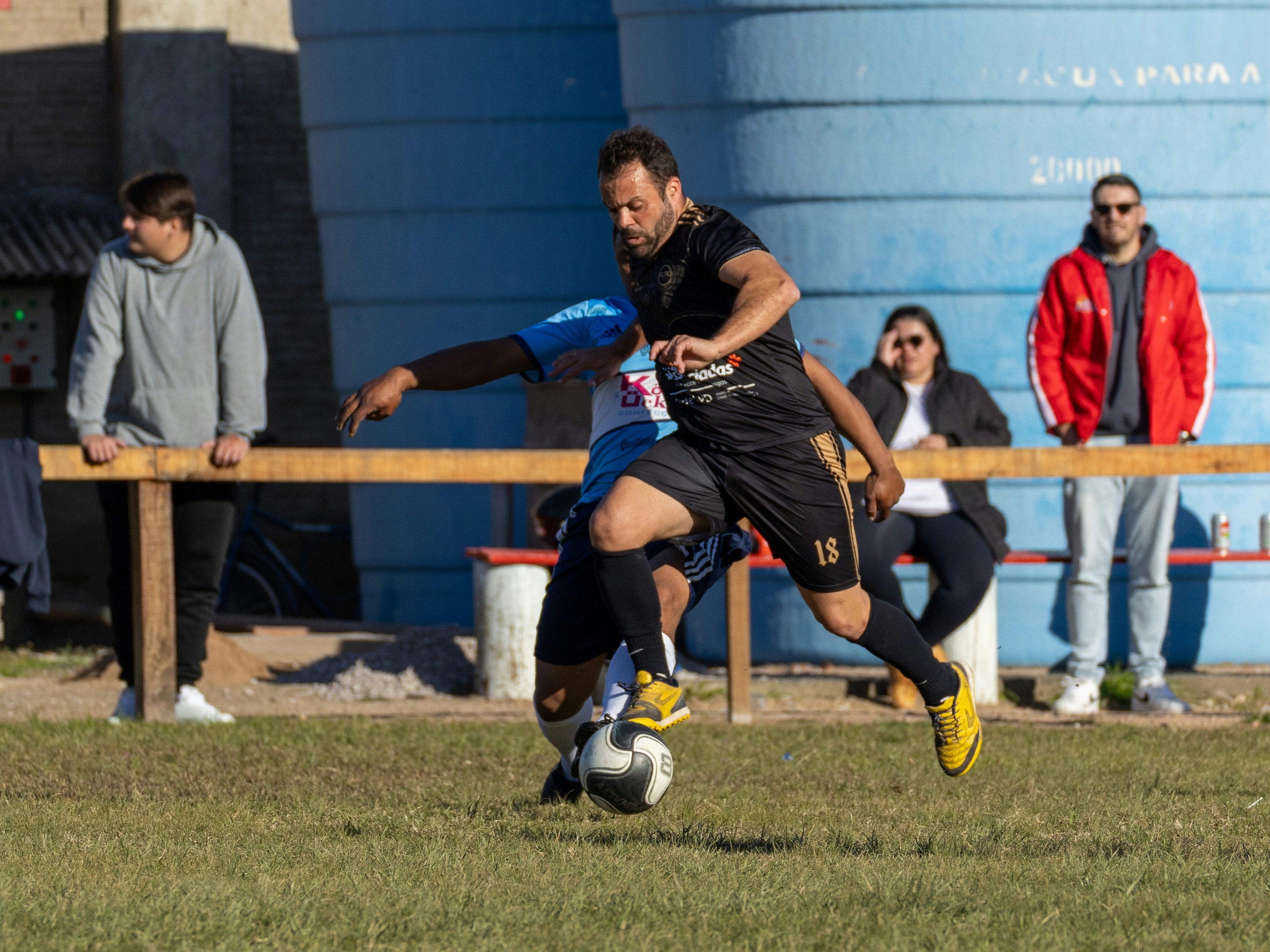 Midfield dash: a striker powers through a challenge