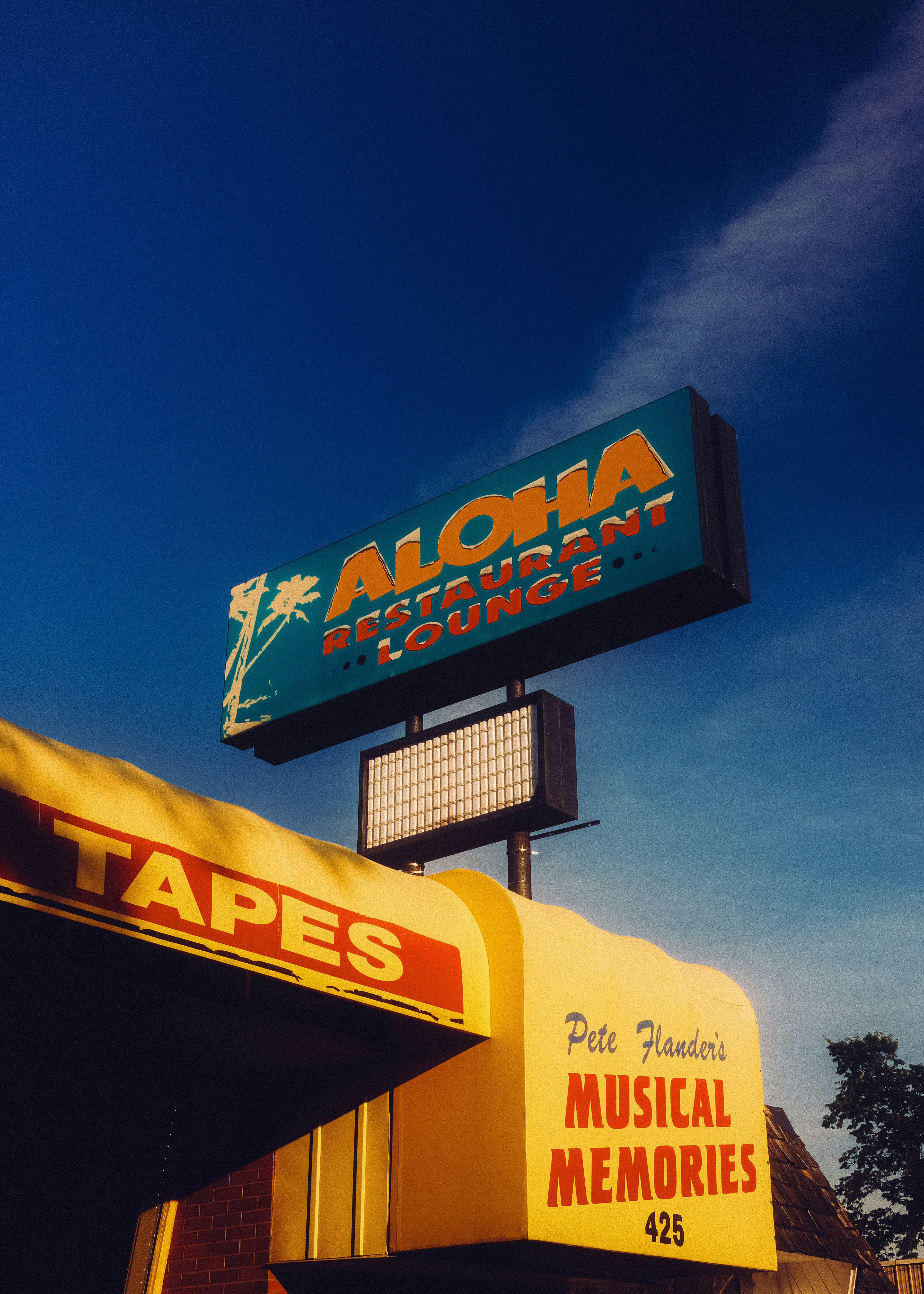 Aloha Sign Over Bright Yellow Tapestry of Memories