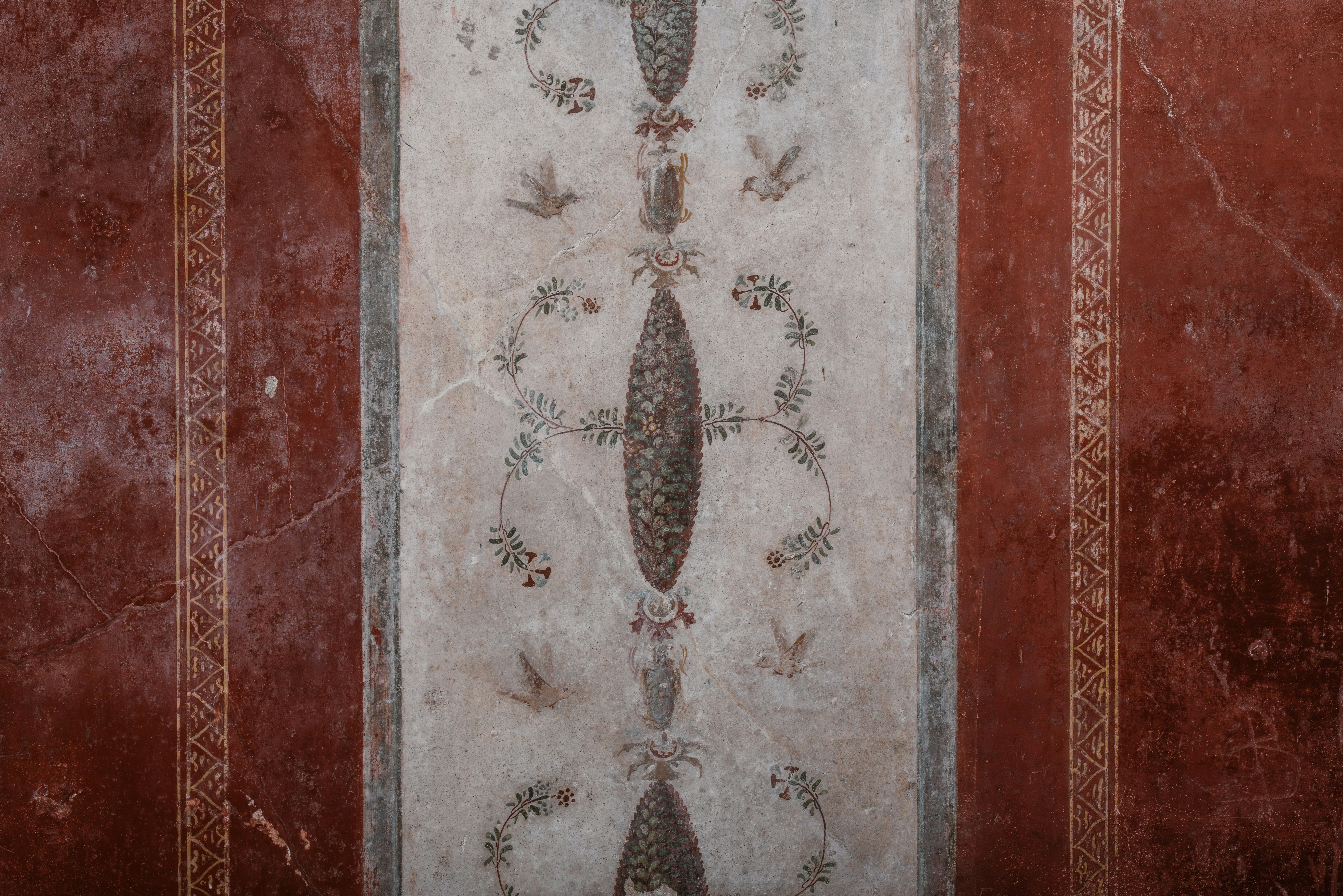 Vertical Mosaic: Ornate Central Panel on Weathered Red Wall