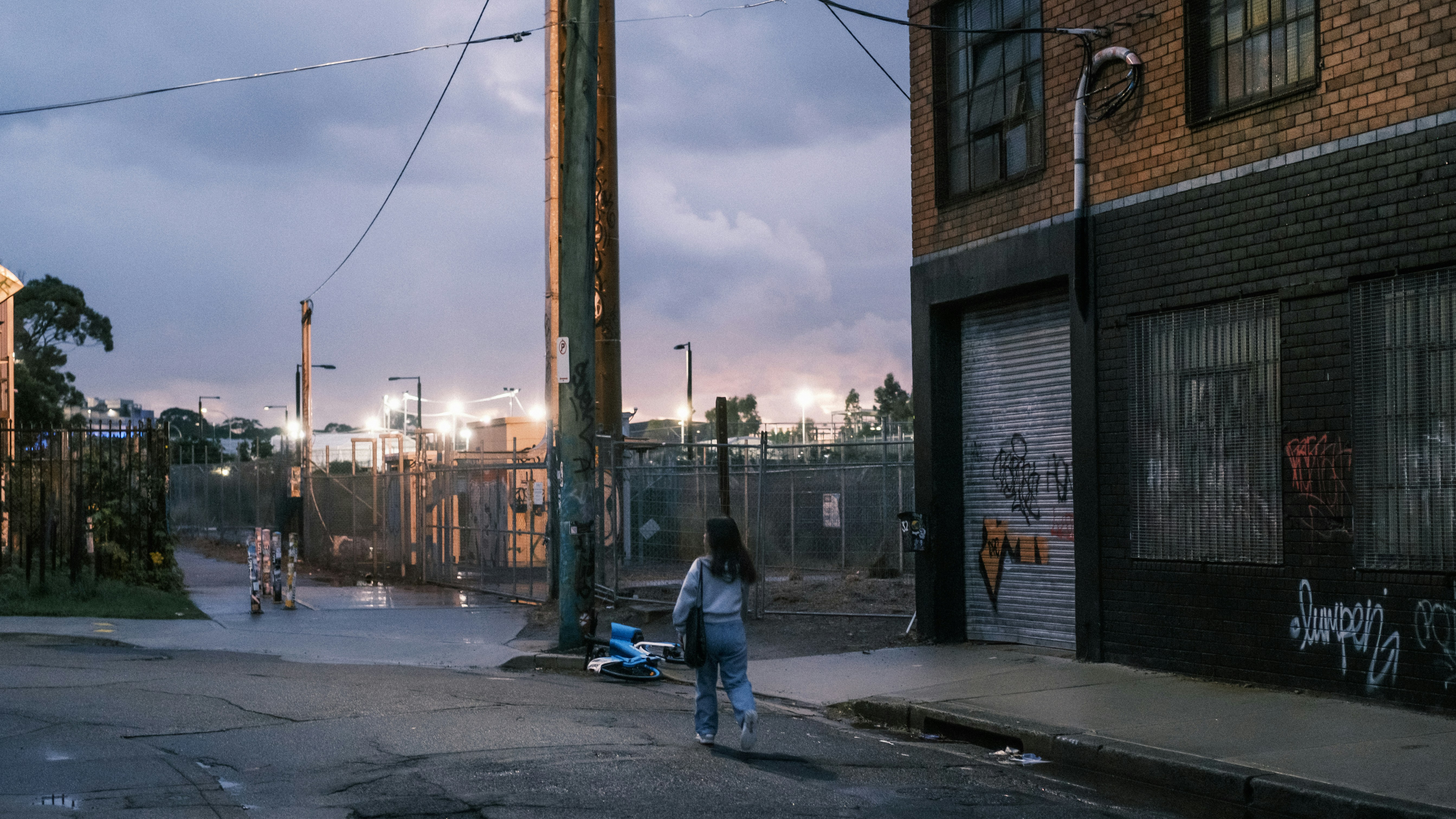 Midtown Run: A lone figure on a rain-soaked street