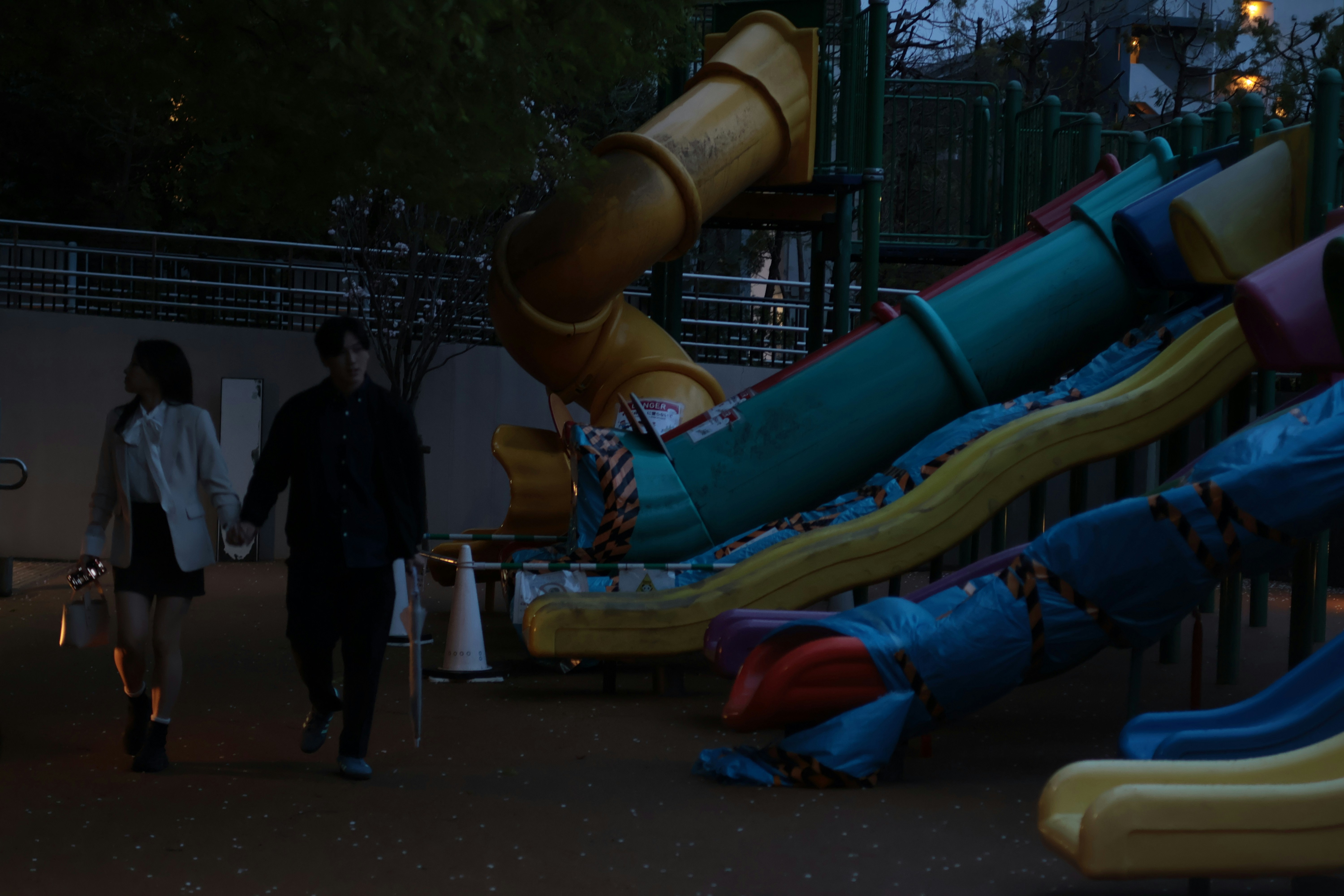 Dim Evening at a Colorful Slide: Quiet Playground After Sunset