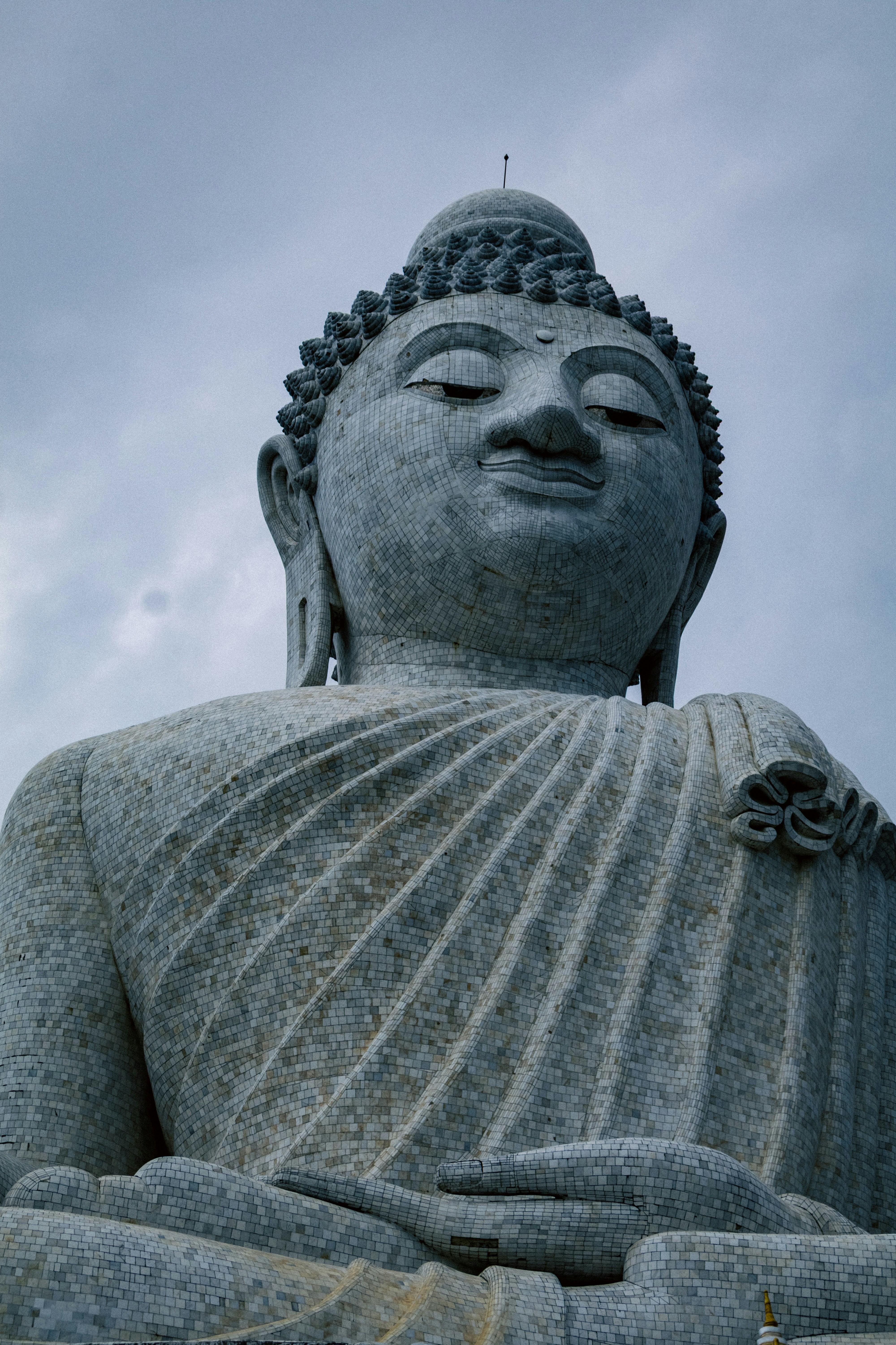 Serene Prominence: A Meditative Buddha Statue Against a Quiet Sky