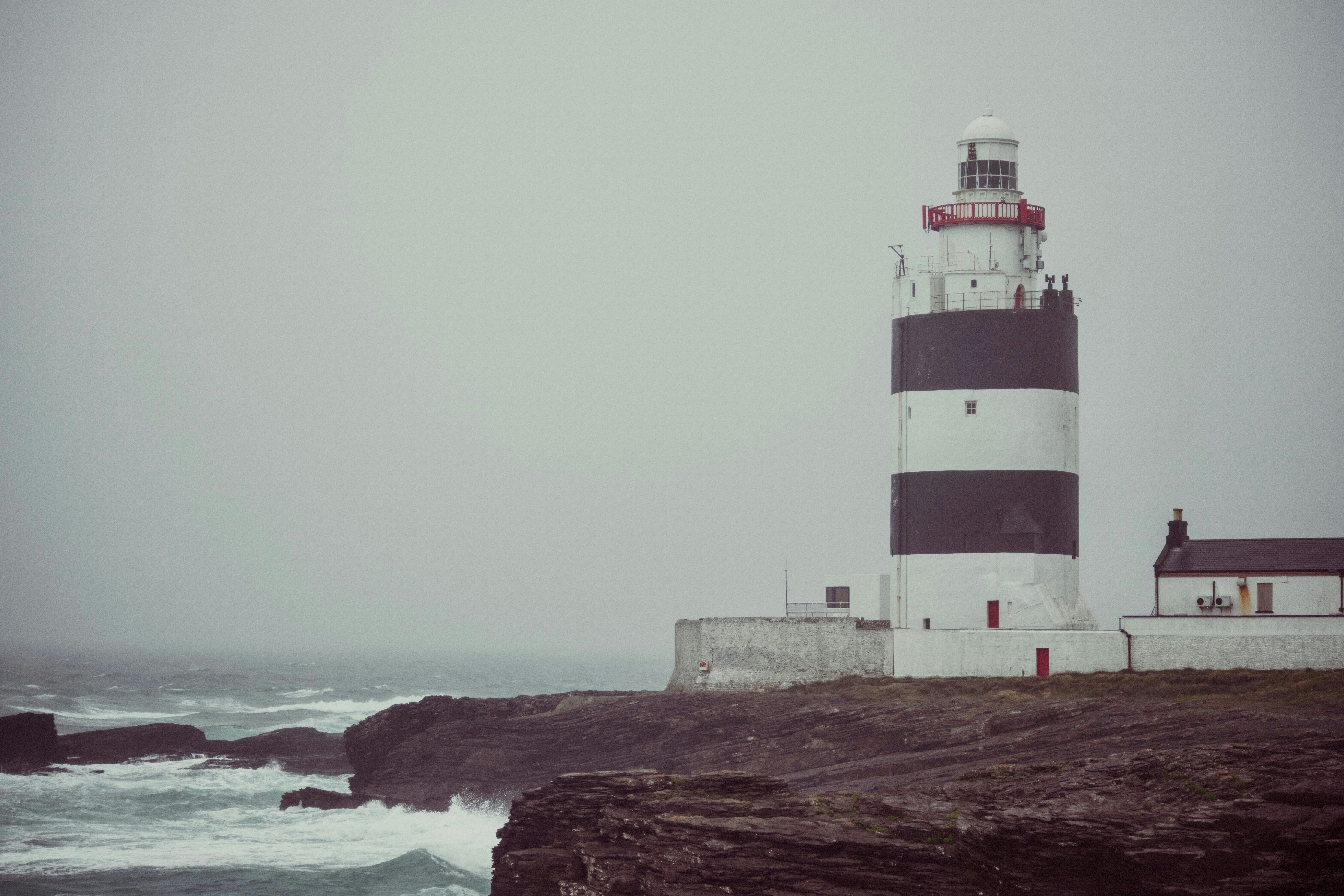 Coastal Beacon: The White-and-Black Tower Standing Against the Sea