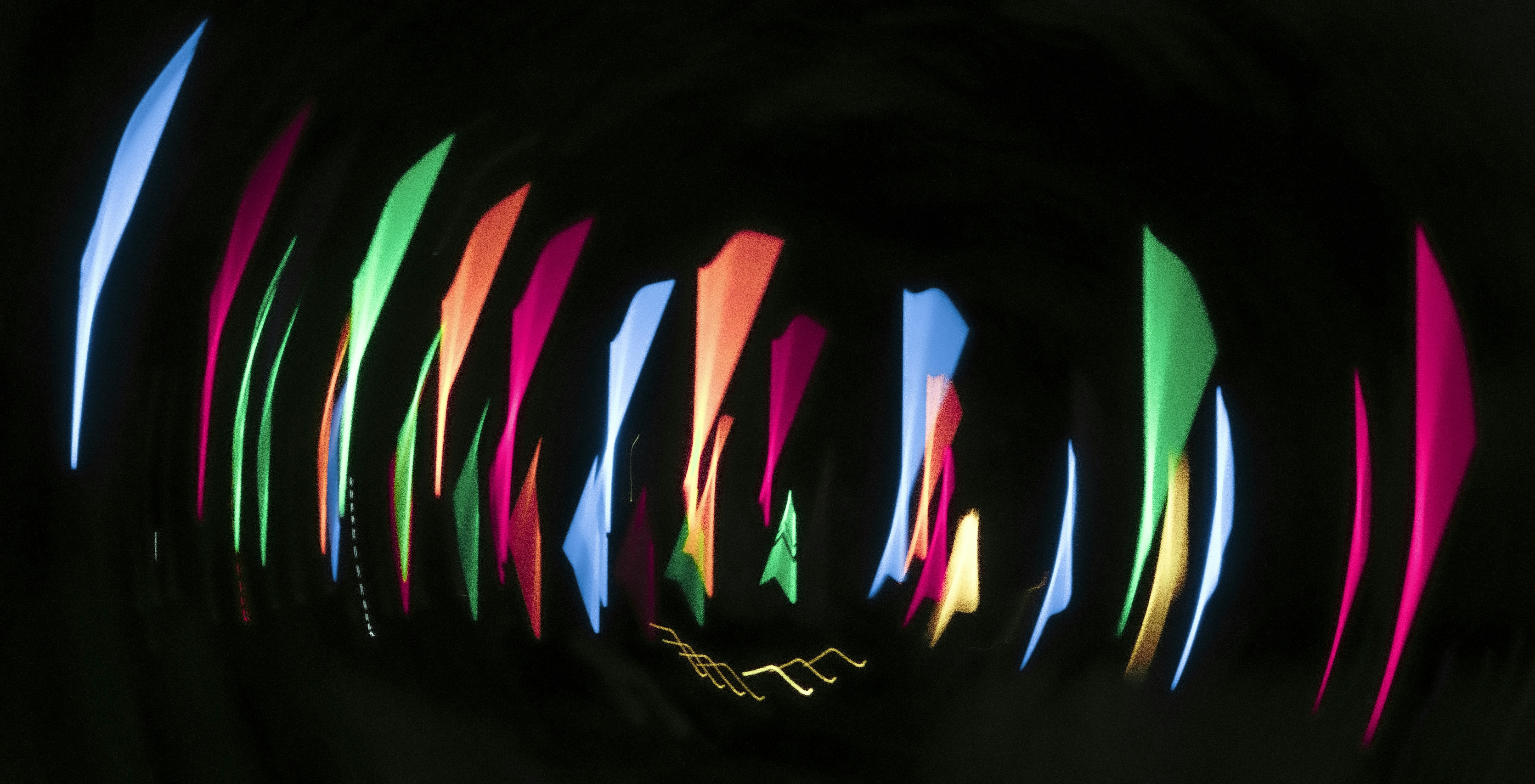 Neon Ribbon Parade: Colors in motion through a dark tunnel