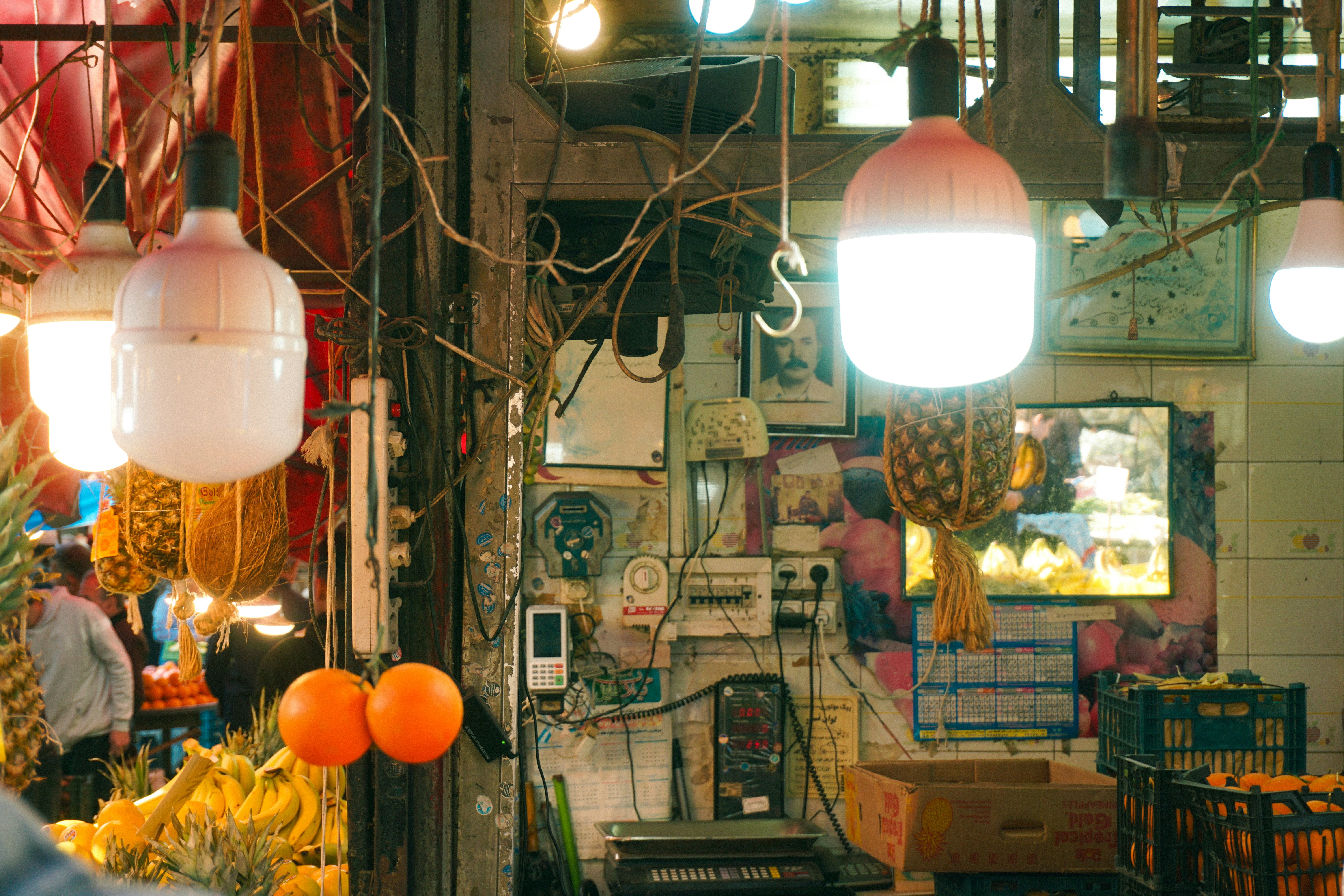 Orange Orbs and Neon Hue: A Bustling Market Nook