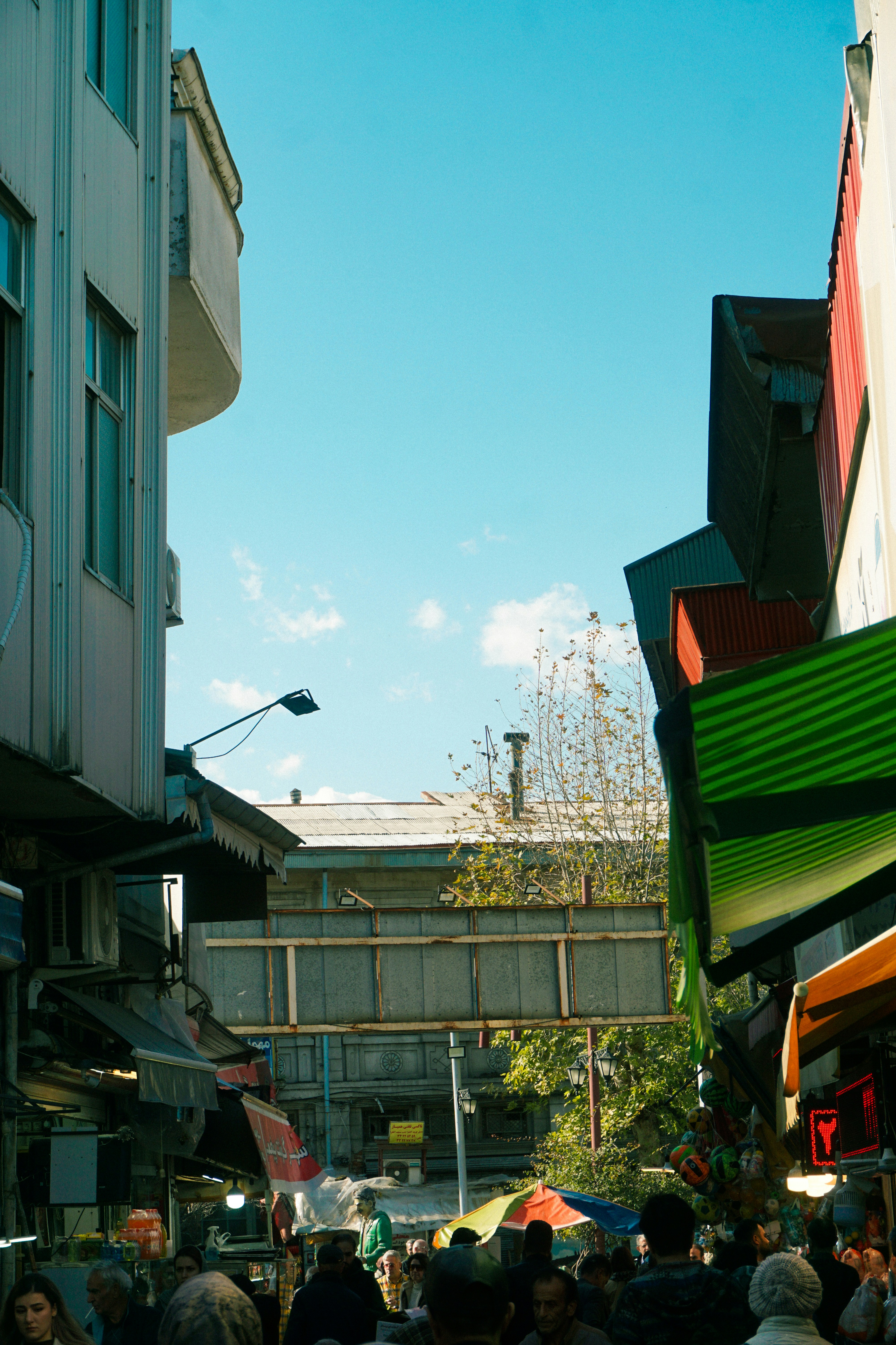 Sunlit Market Corridor Under a Bright Blue Sky