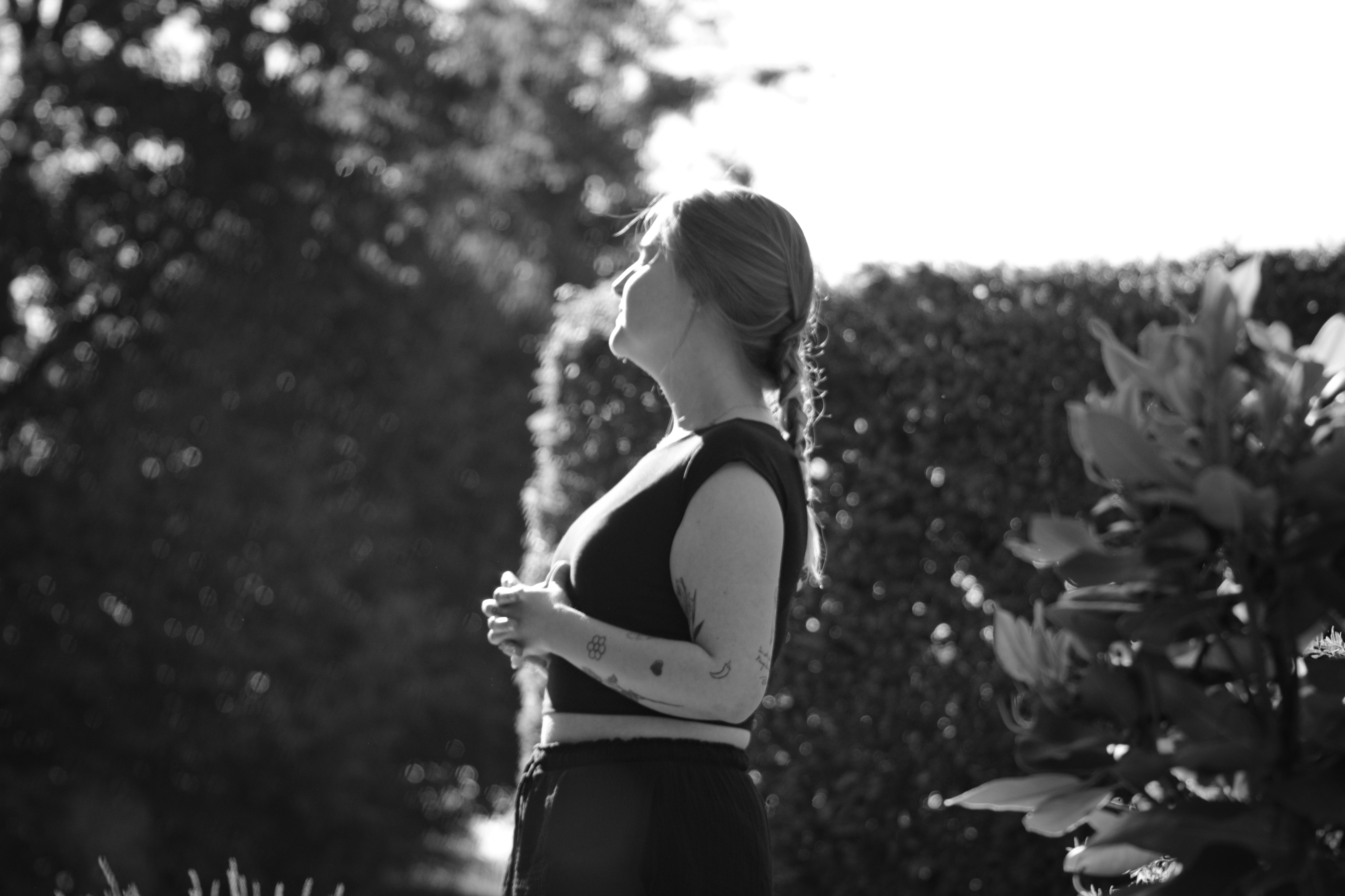 Profile of Quiet Confidence: A Sunlit Moment in Black and White