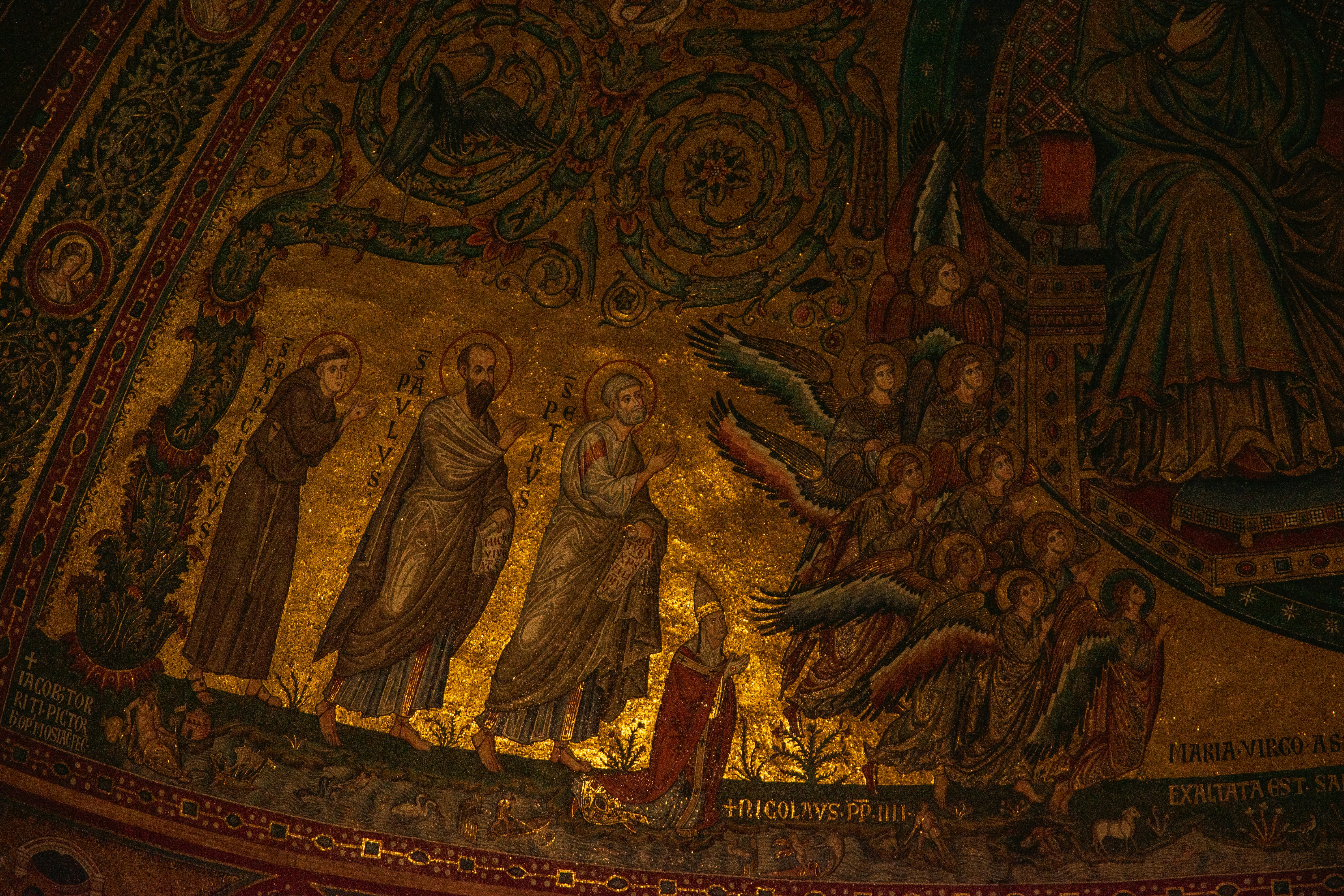 Intricate golden mosaic depicting religious figures on a curved ceiling.