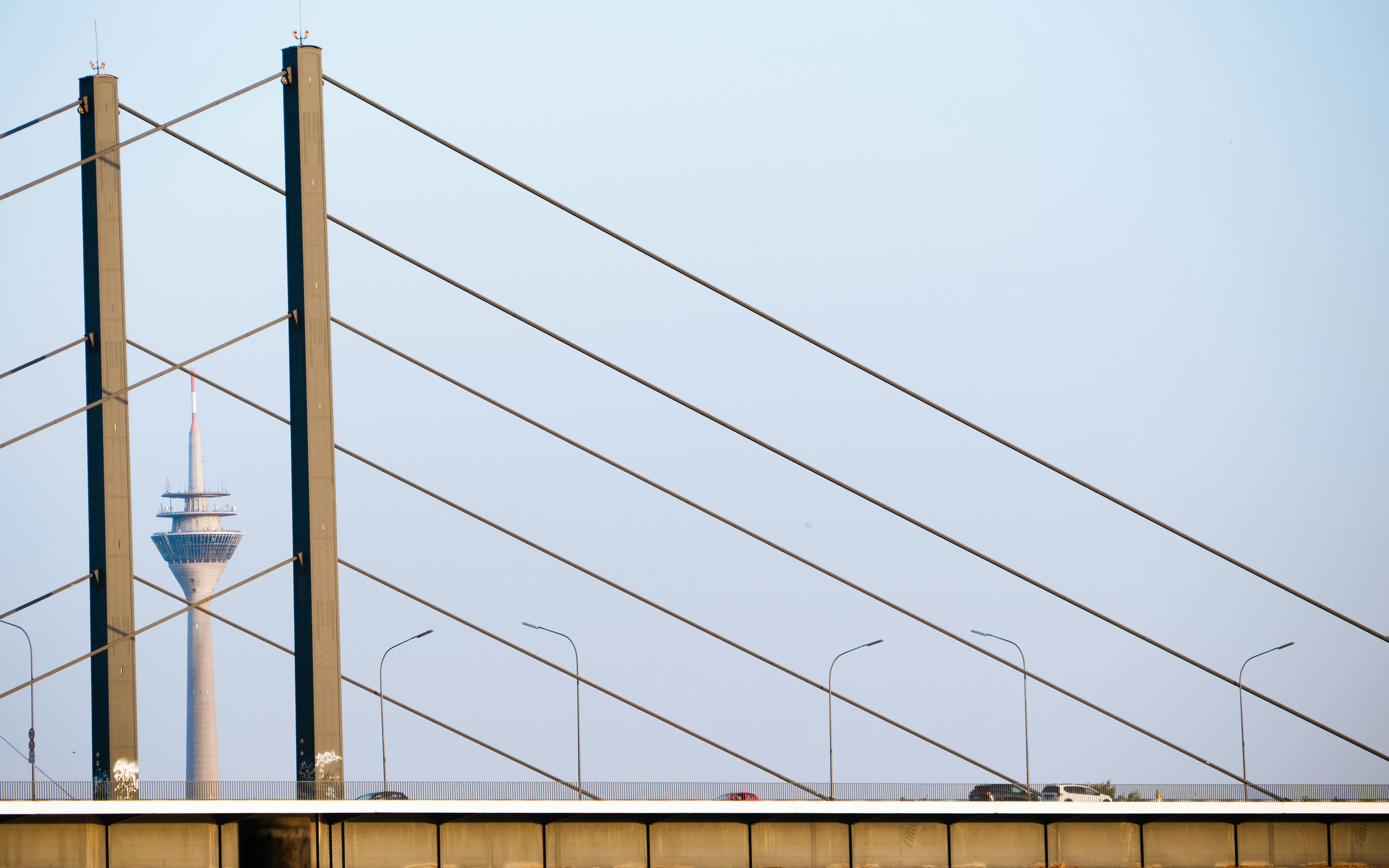 Towering Lines Meet the Skyline: A Commuter Bridge Silhouette