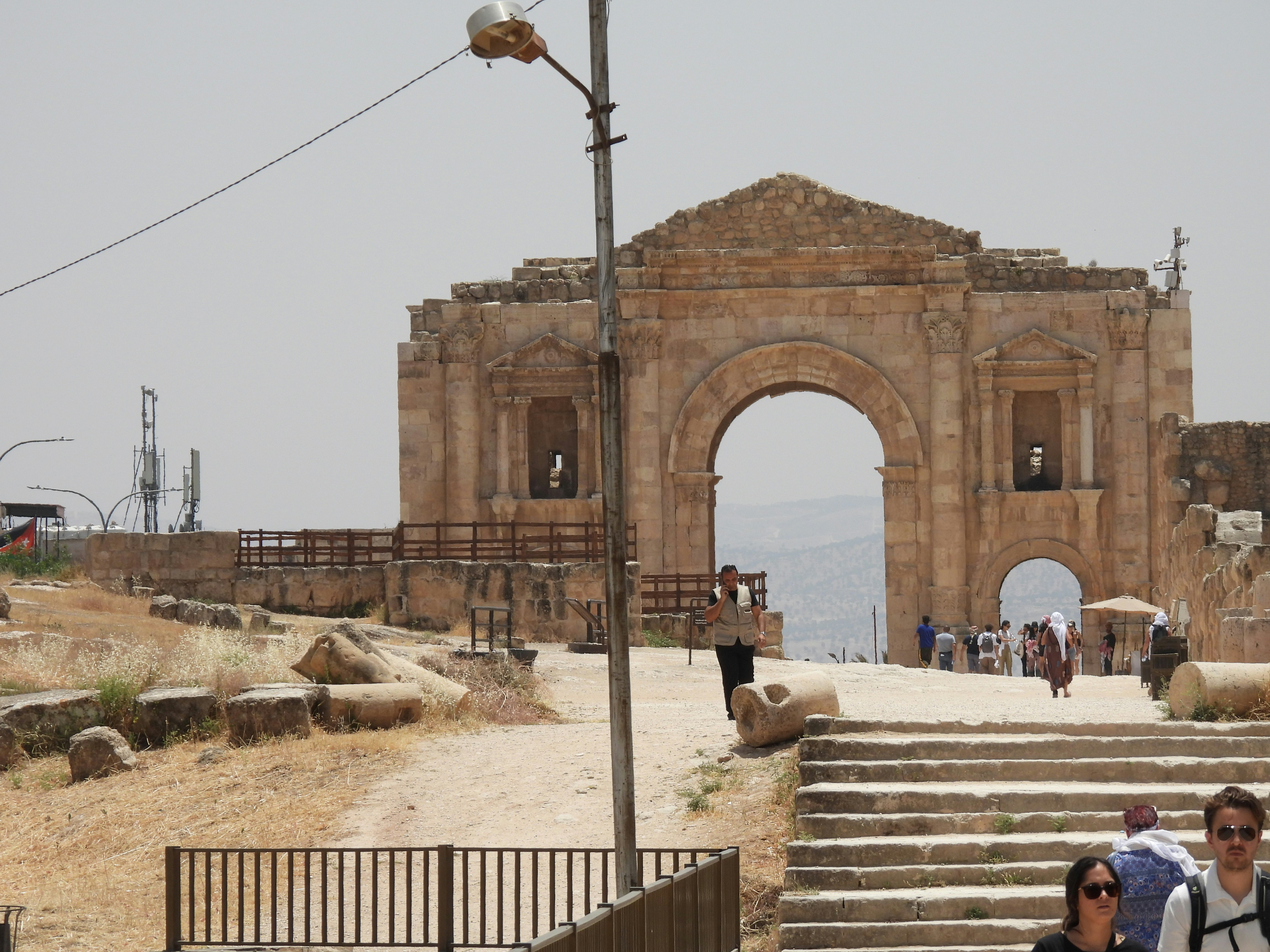 Gateway to the Ancient Gatehouse: Visitors at the Arch in a Desert Citadel