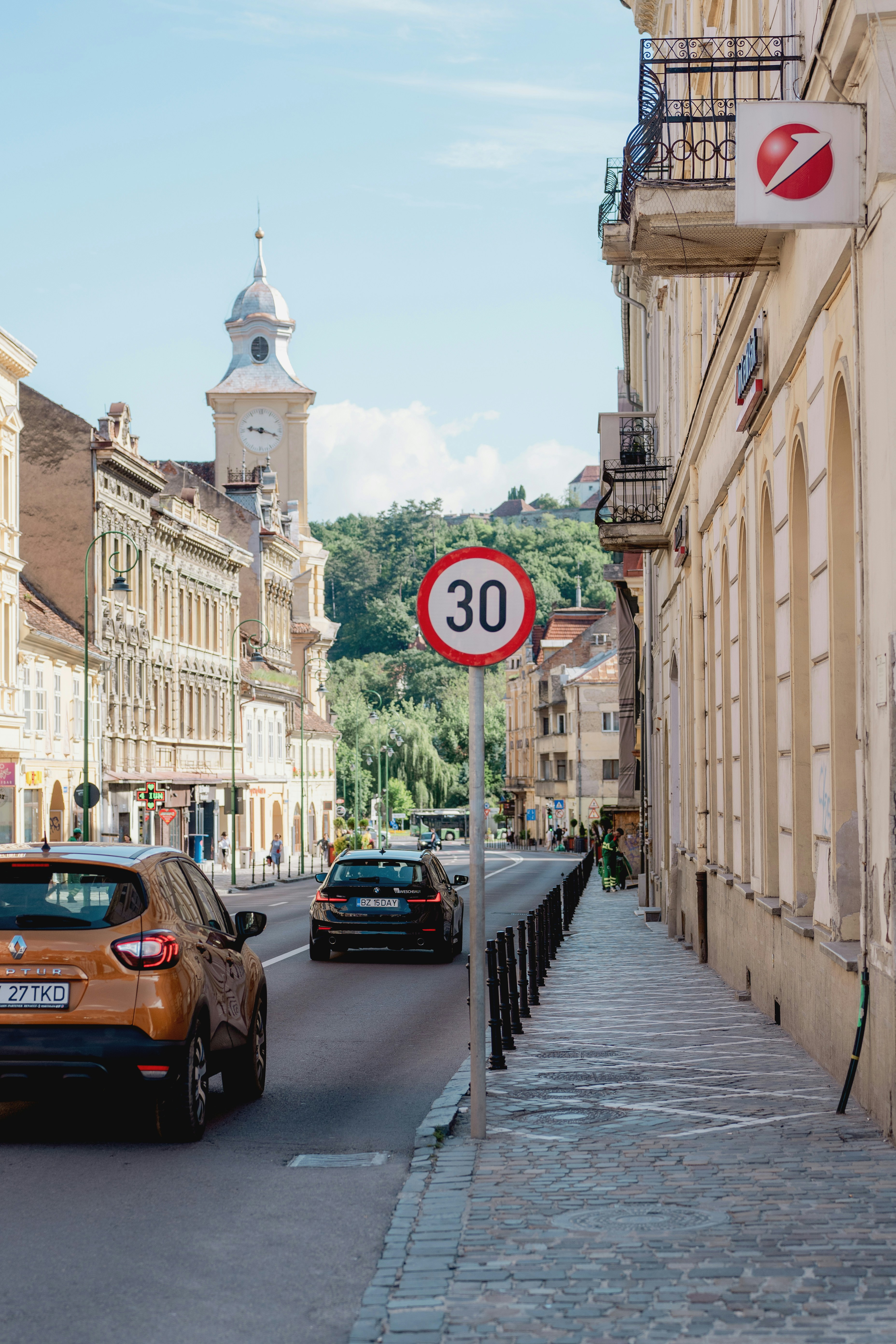 Street Scene in a European Town with 30 km/h Sign and Clock Tower