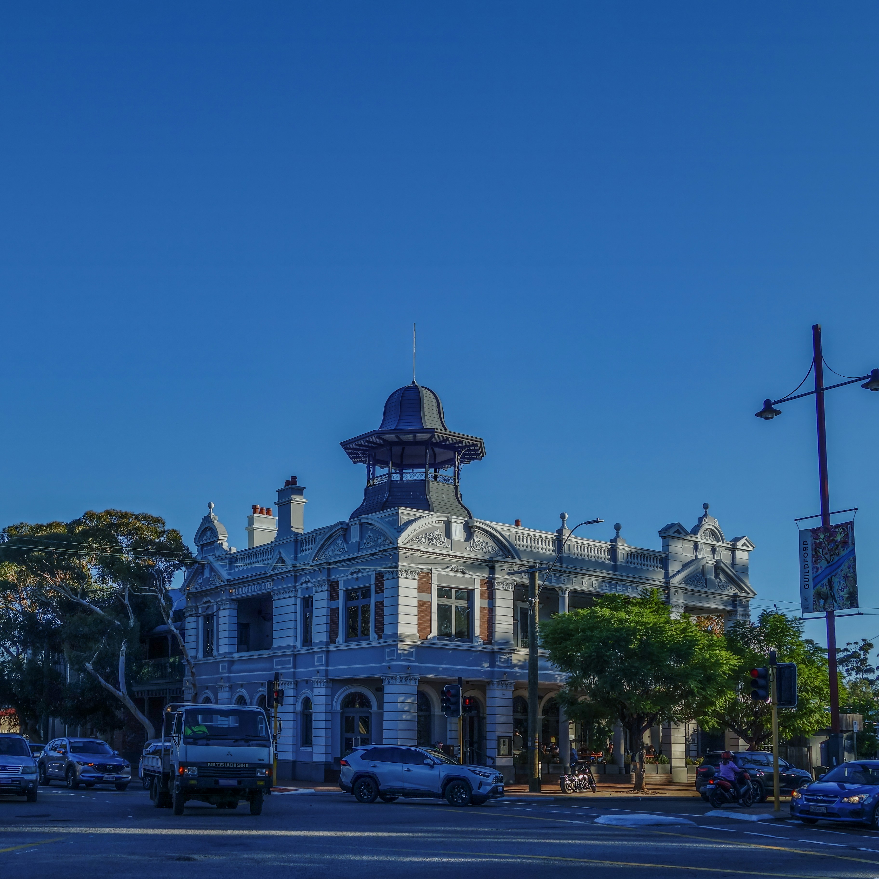 Cornerstone of the Cornerhouse: a sunlit heritage building at a busy intersection