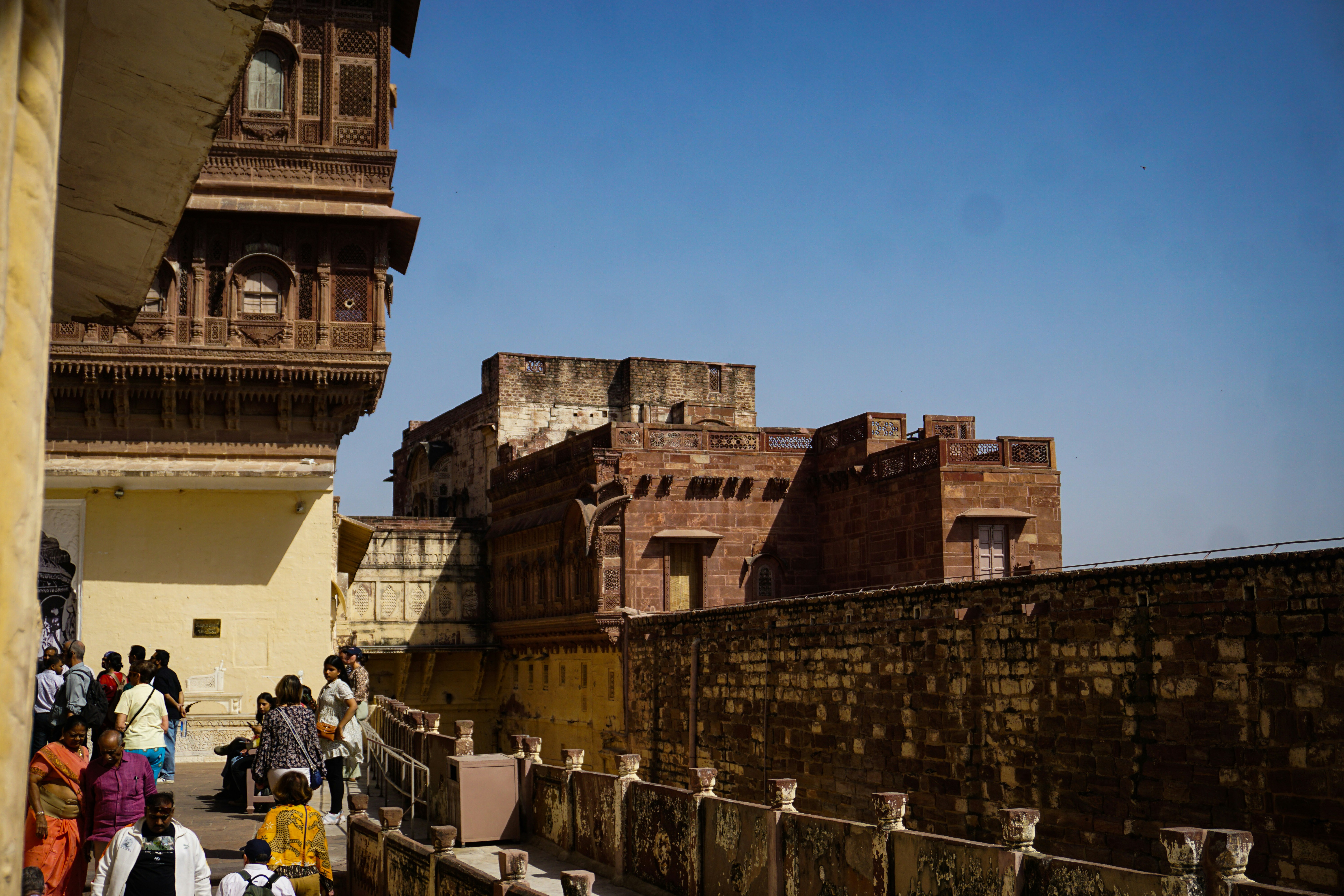 People at the Fort Wall Beneath a Carved Balcony