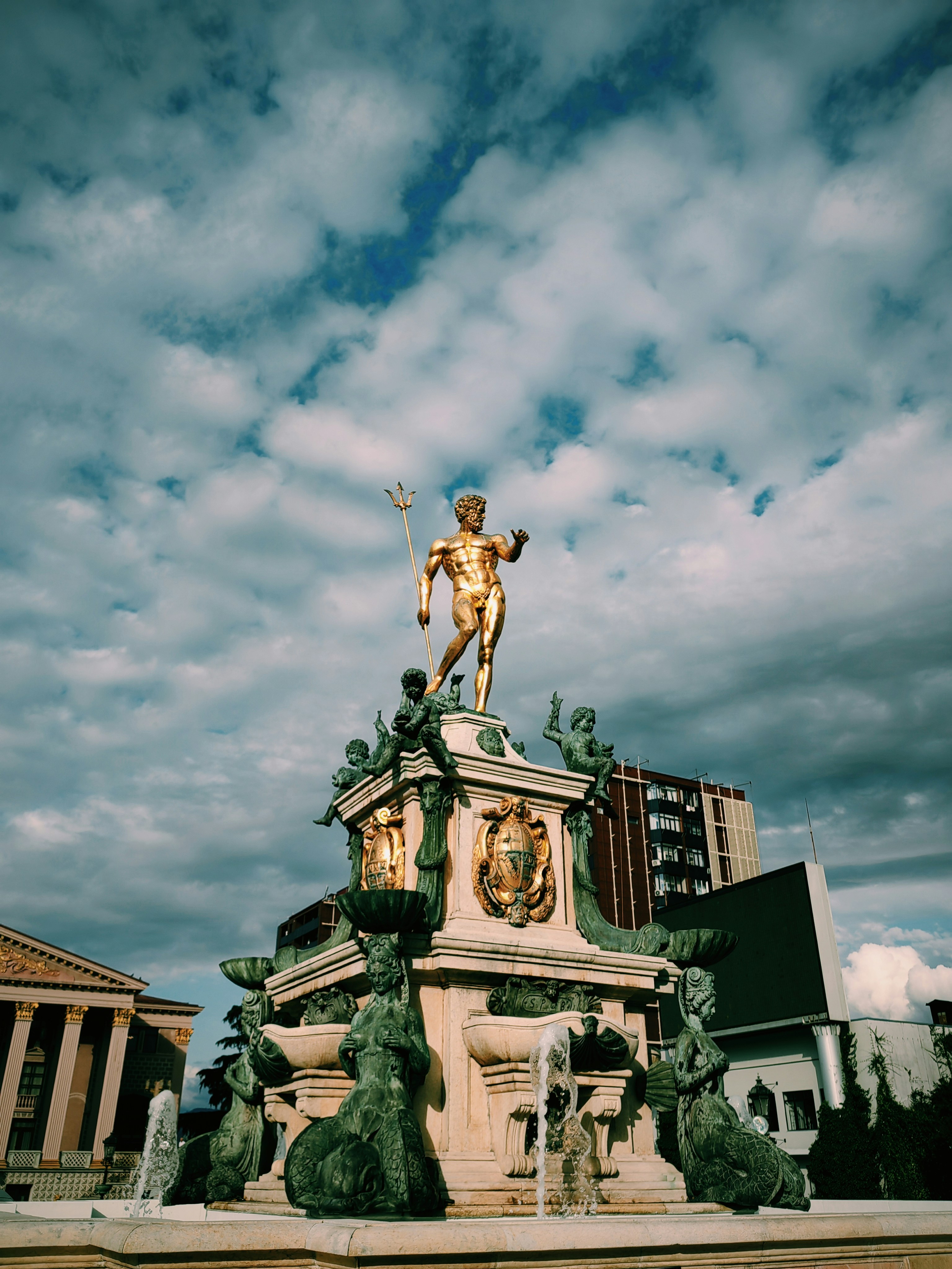 Golden Statue, Green Cherubs, and Urban Sky