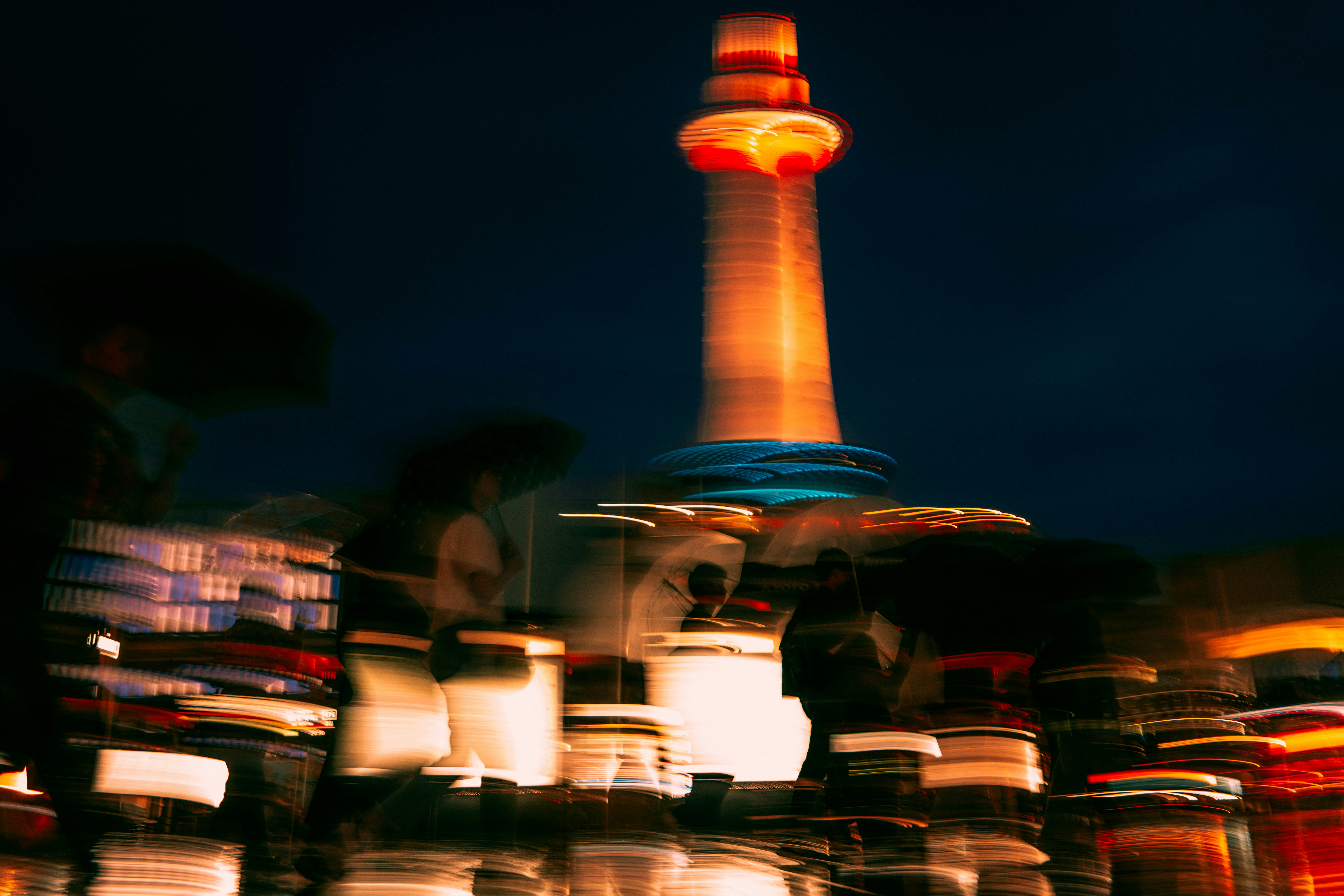 Luminous Beacon Above a Blurred Night Market