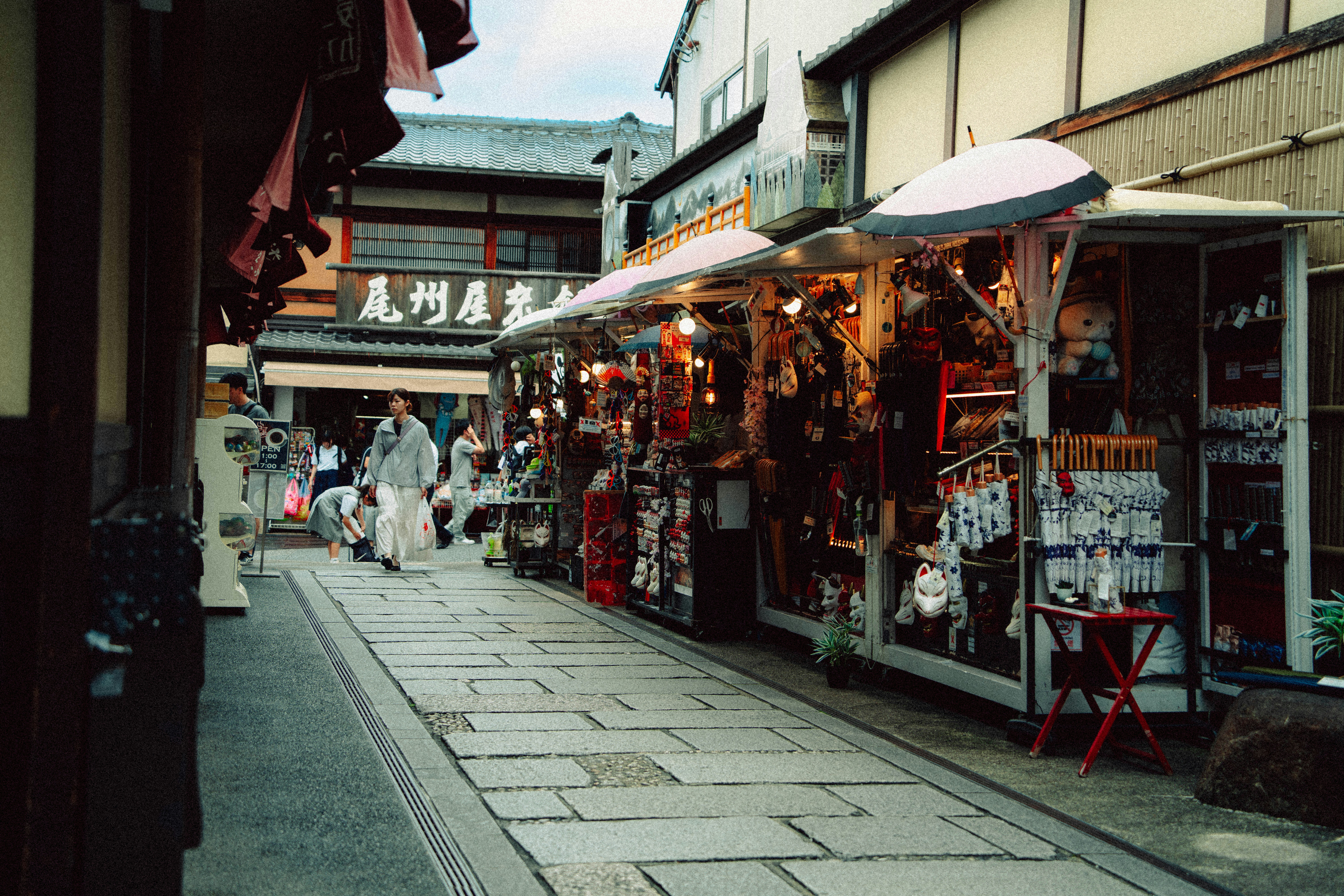 Narrow Market Lane: Lanterns, Goods, and Quiet Motion