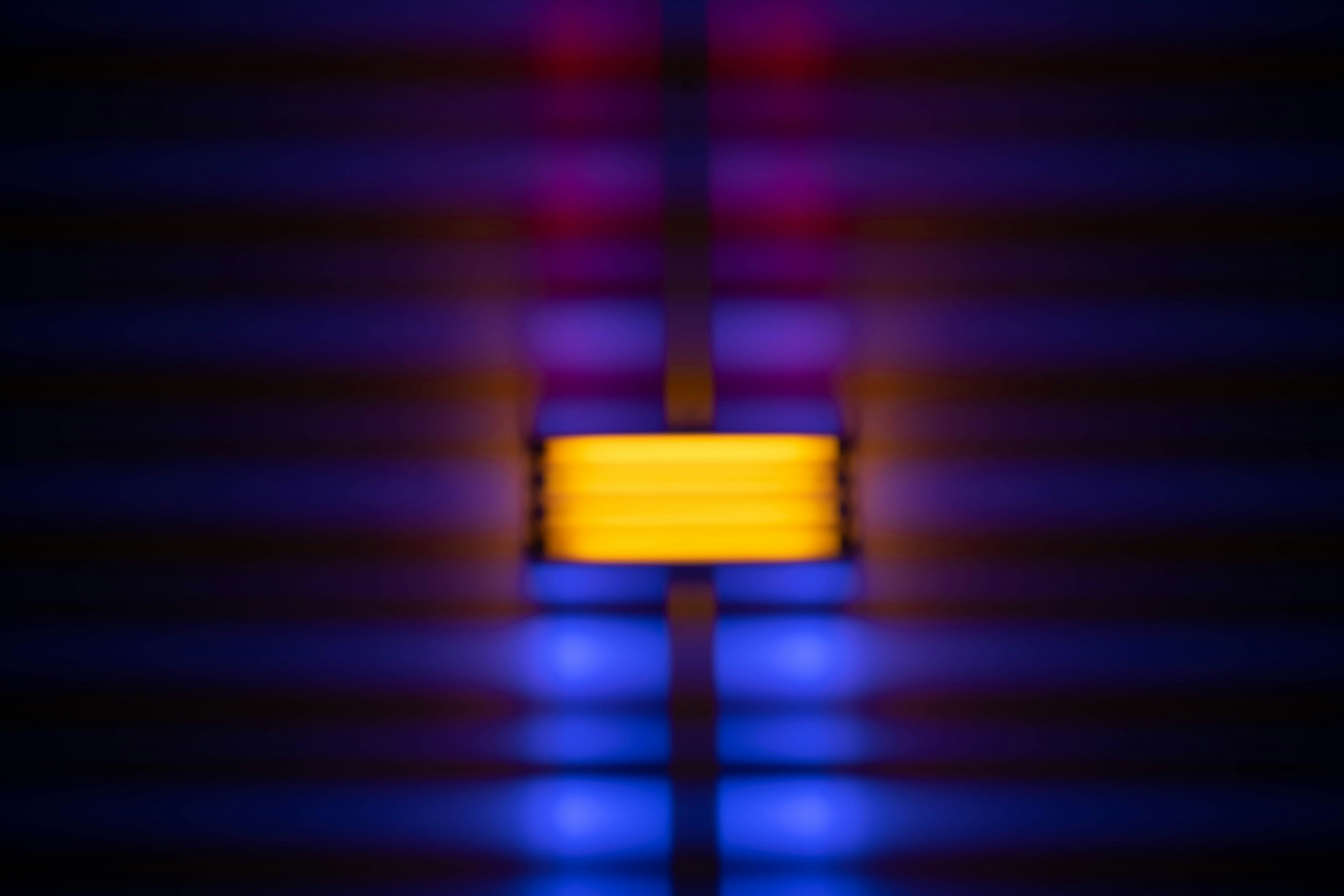 Neon Ring in the Dark: A Soft-Blured Striped Blue Glow with a Central Yellow Accent