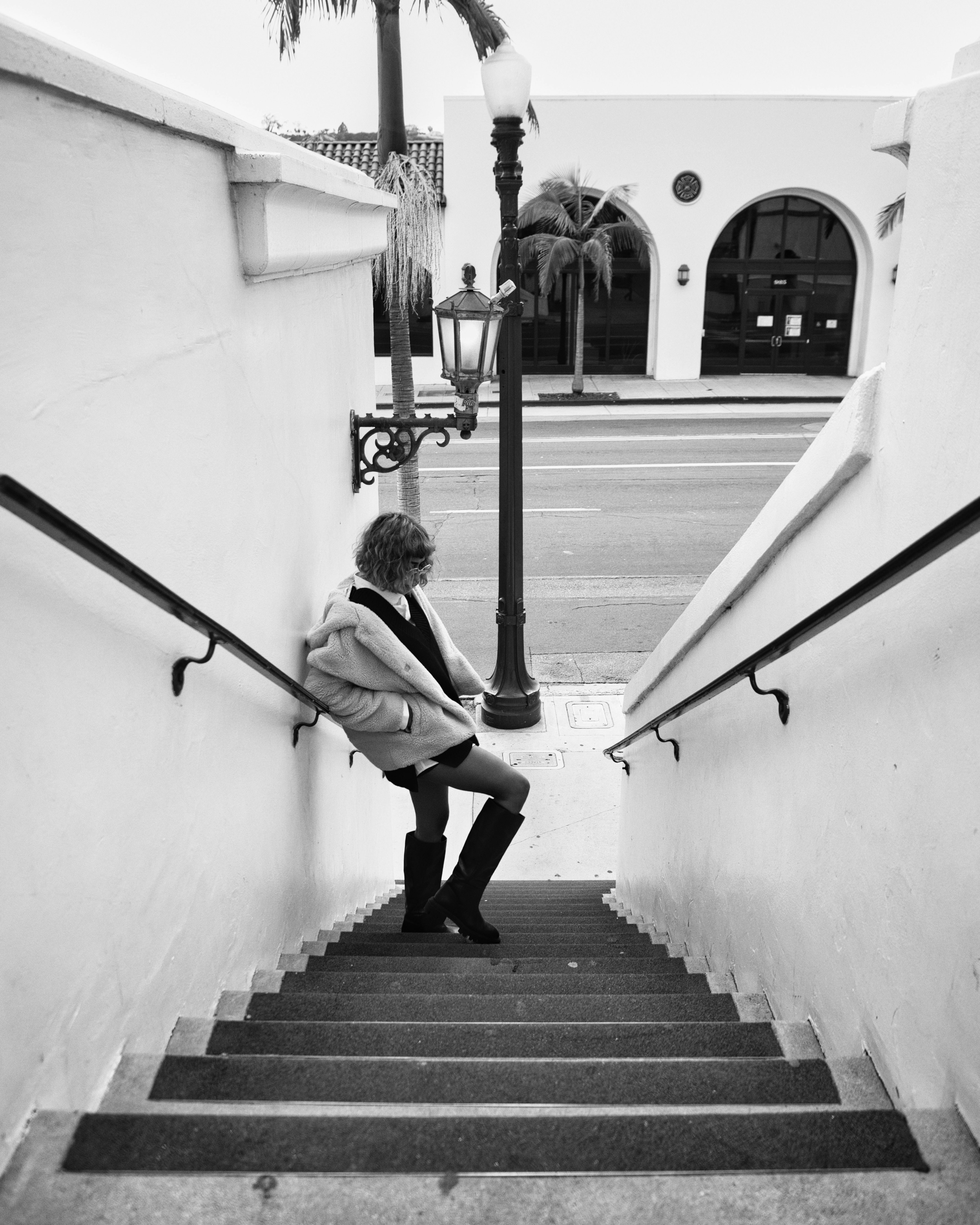 Mid-Stair Quiet: A Woman Pauses on a Sunken Spanish Steps