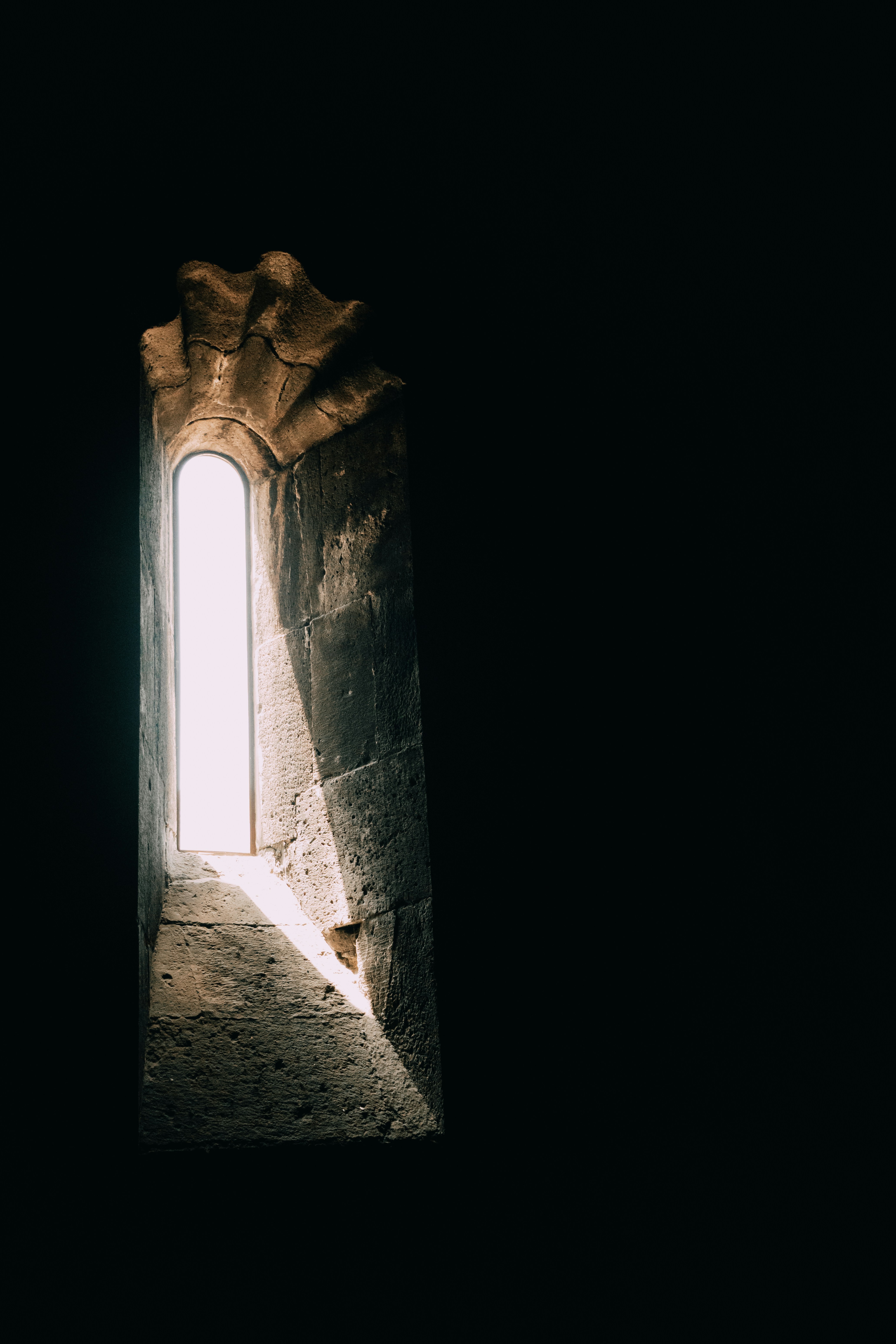 Light in the Narrow Arch: A Glimpse Through Stone Walls