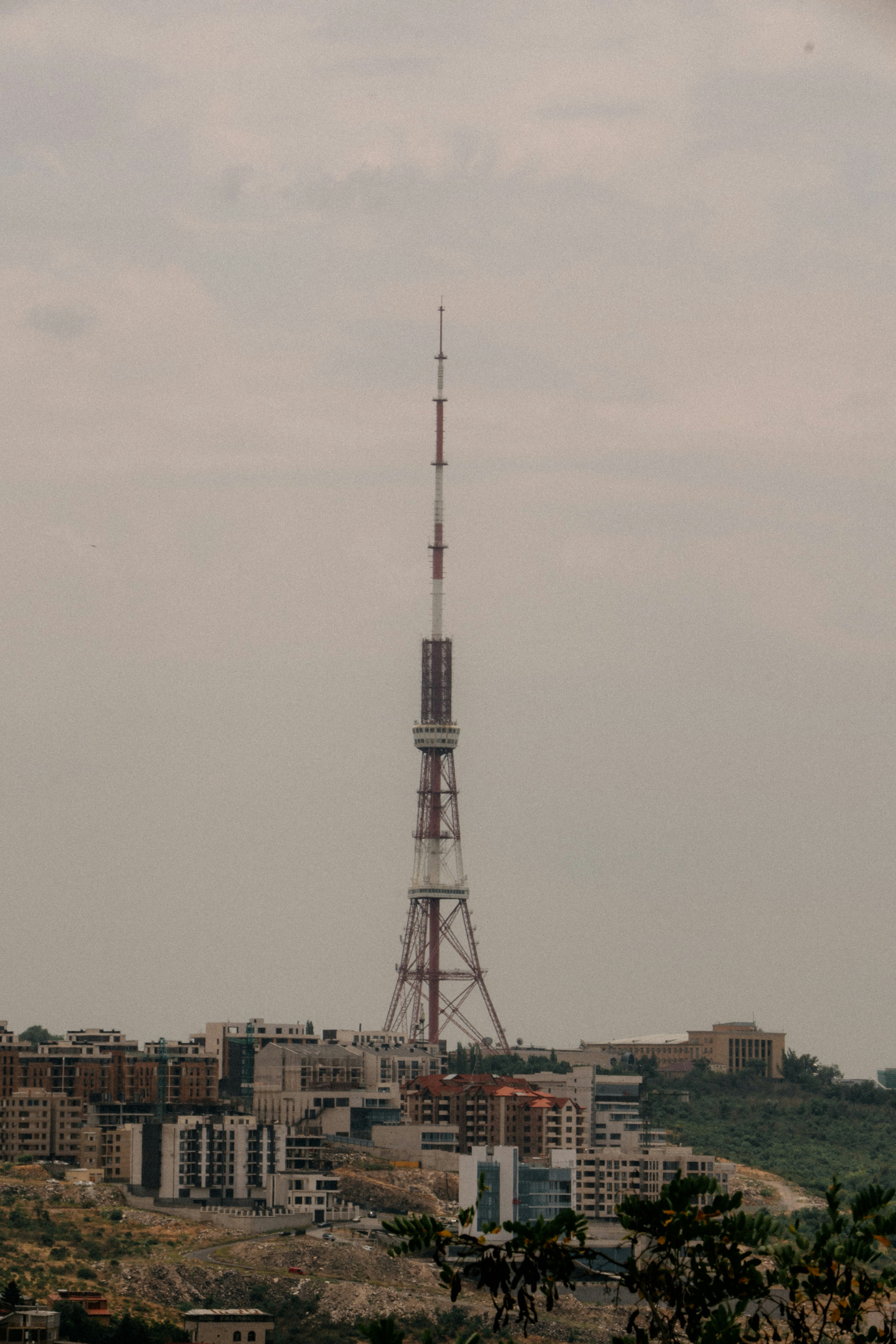 Tower Reach: A Cityscape Crowned by a Sentinel Antenna