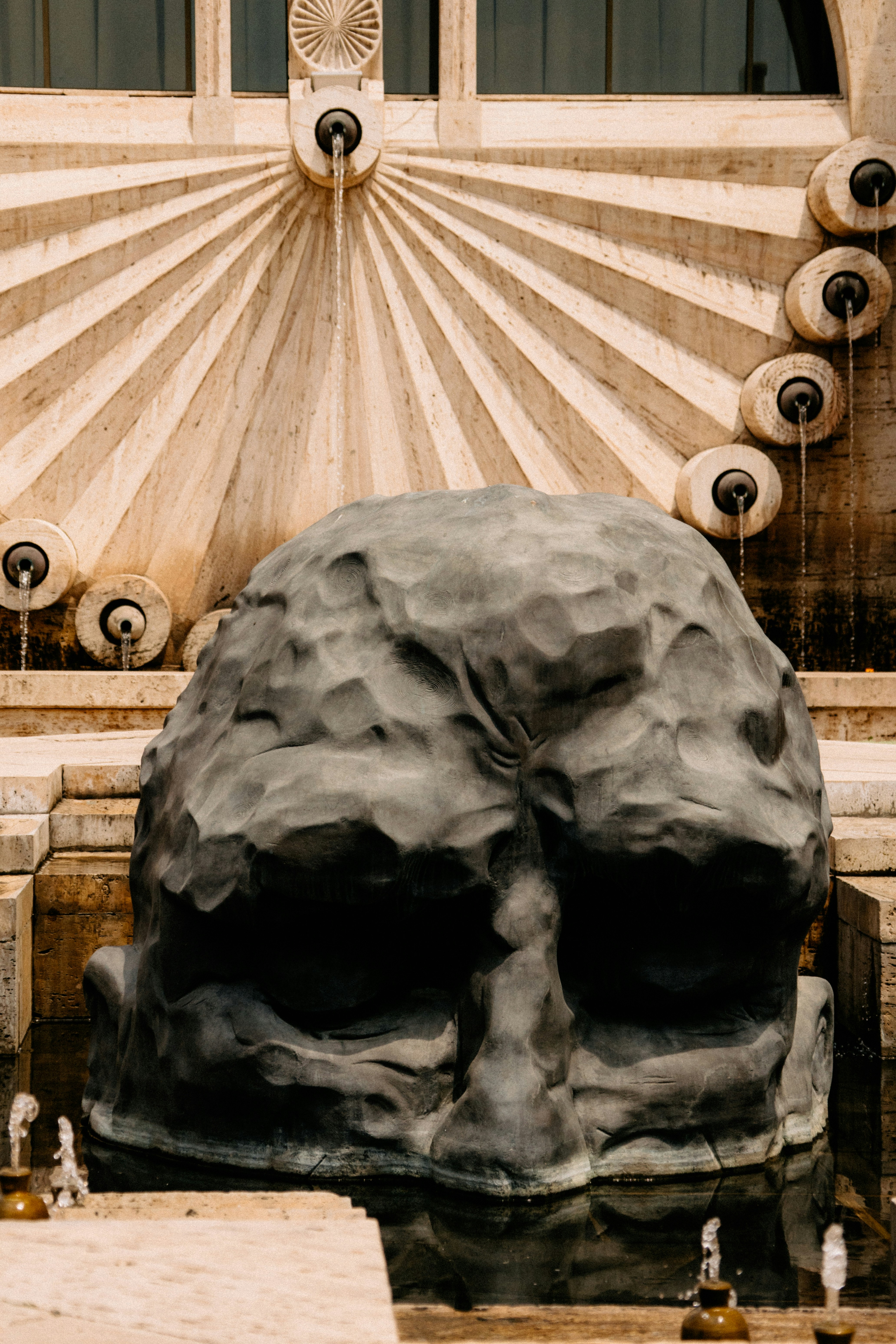 Stone Veil: A Gigantic Head Emerges from Time-etched Fountains