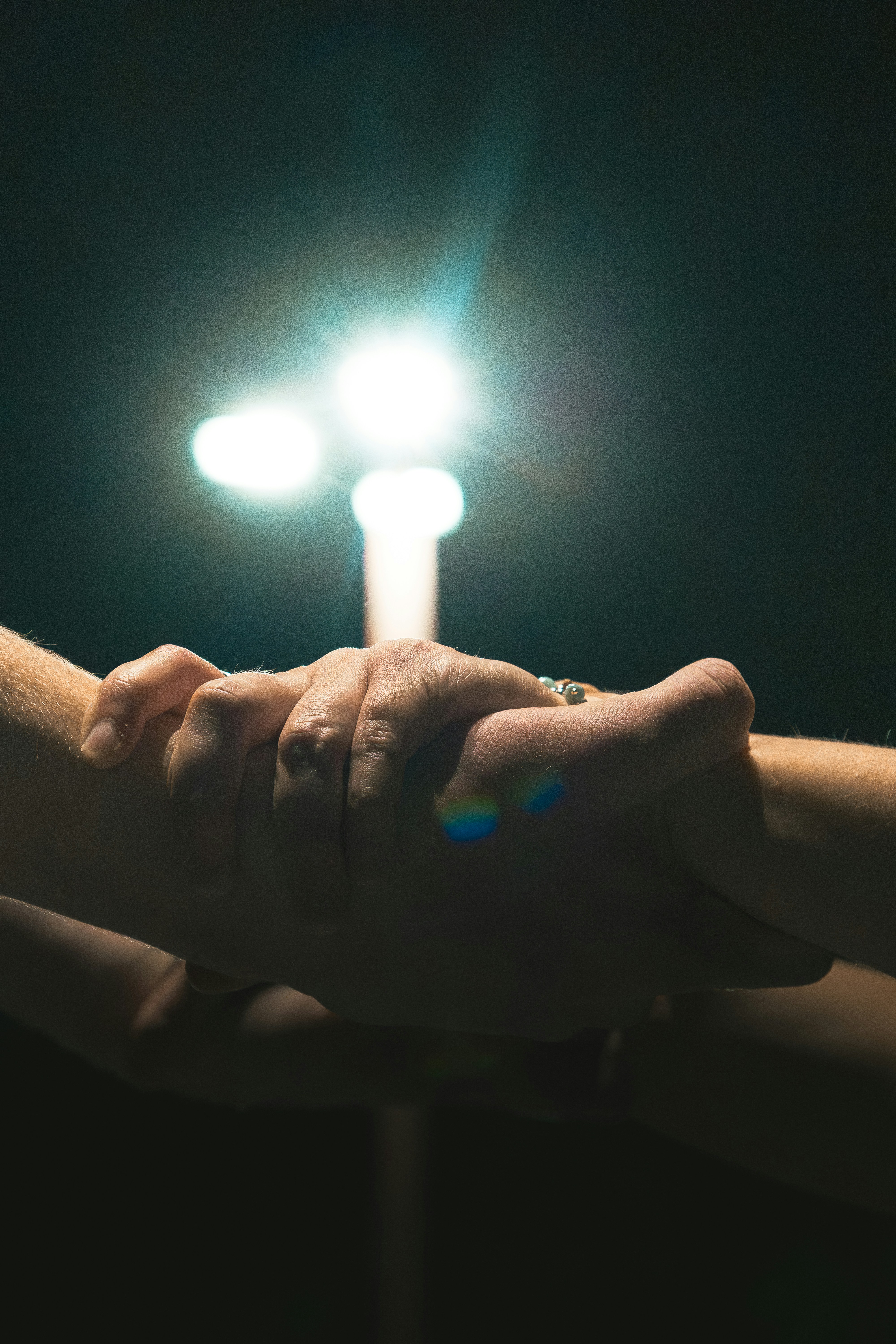 Hands Across the Night: A Silent Bond Under Stadium Lights