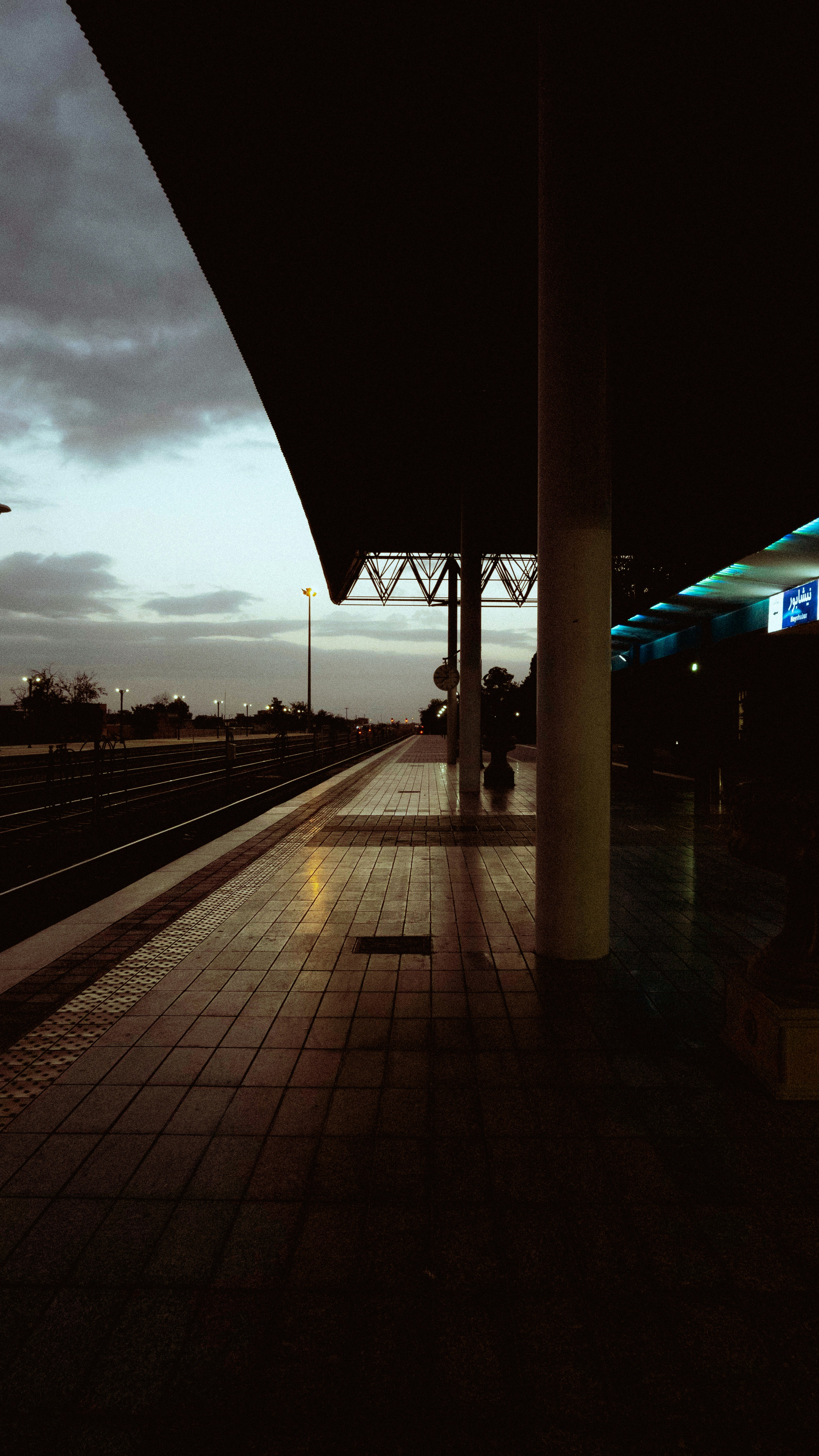 Platform Dusk: Quiet Tracks Under a Modern Canopy
