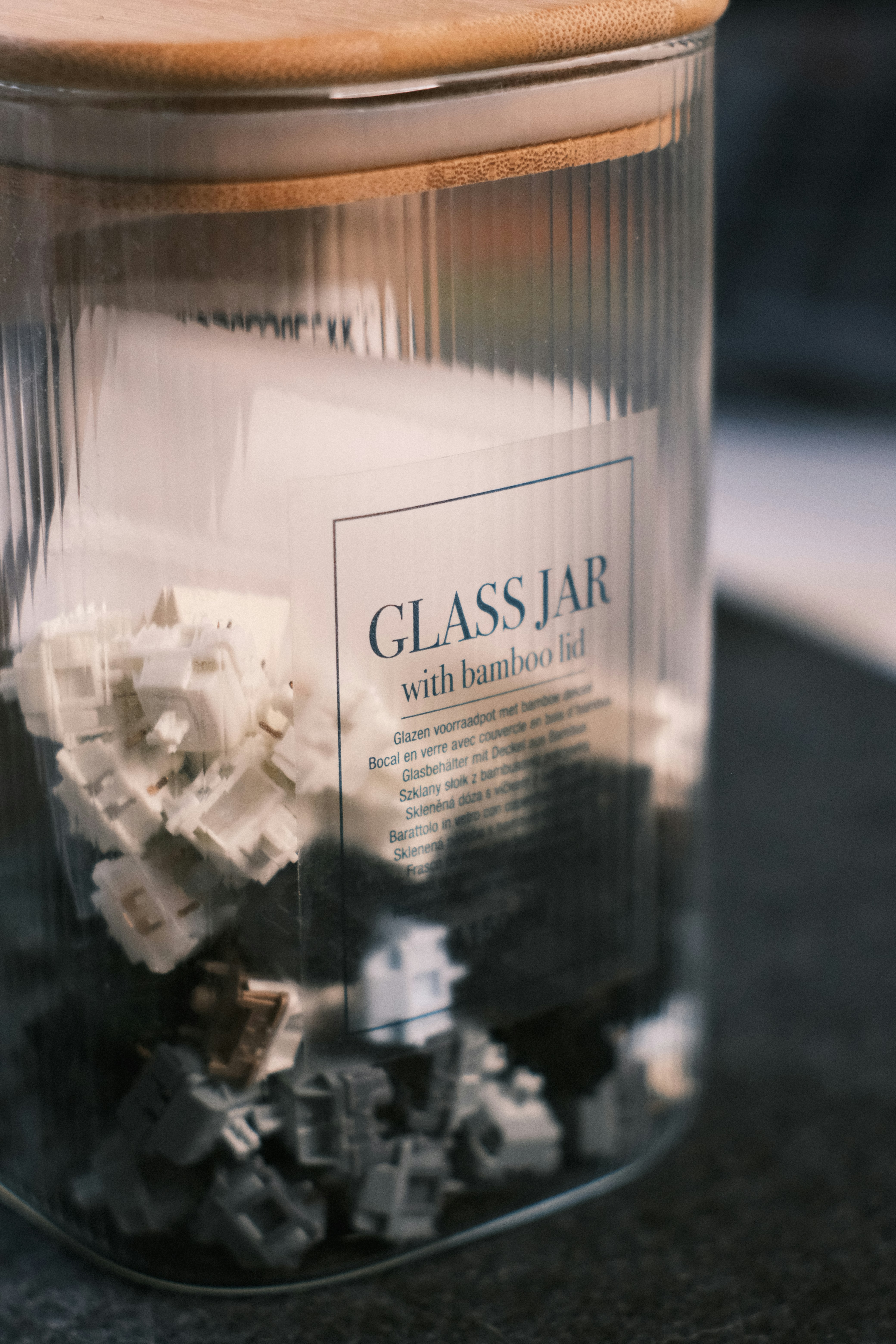 Glass Jar of Miniature Cityscape: A Close-Up of Tiny Architecture Inside Clear Glass