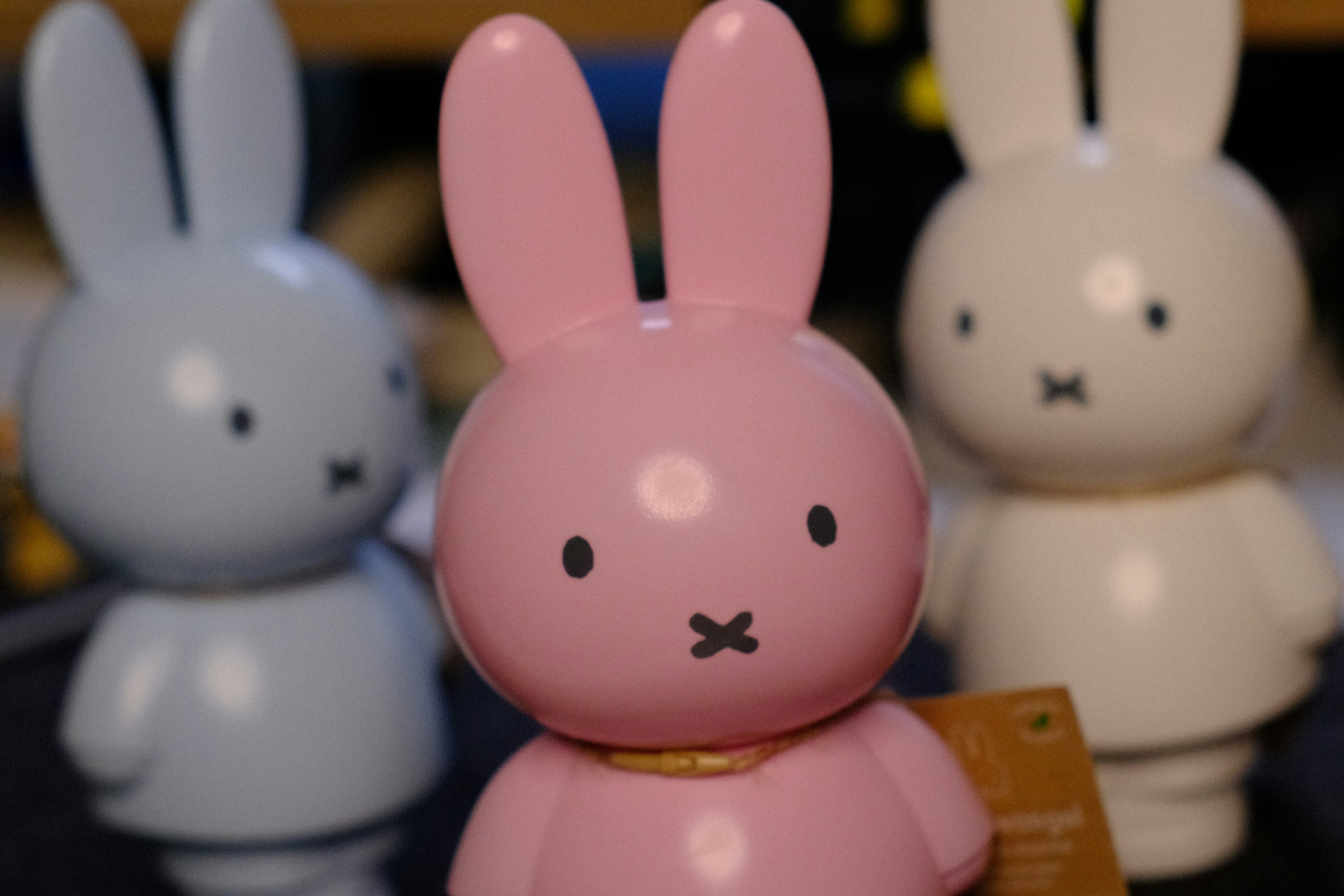 Centered Pink Bunny in a Trio of Blurred Pastel Companions