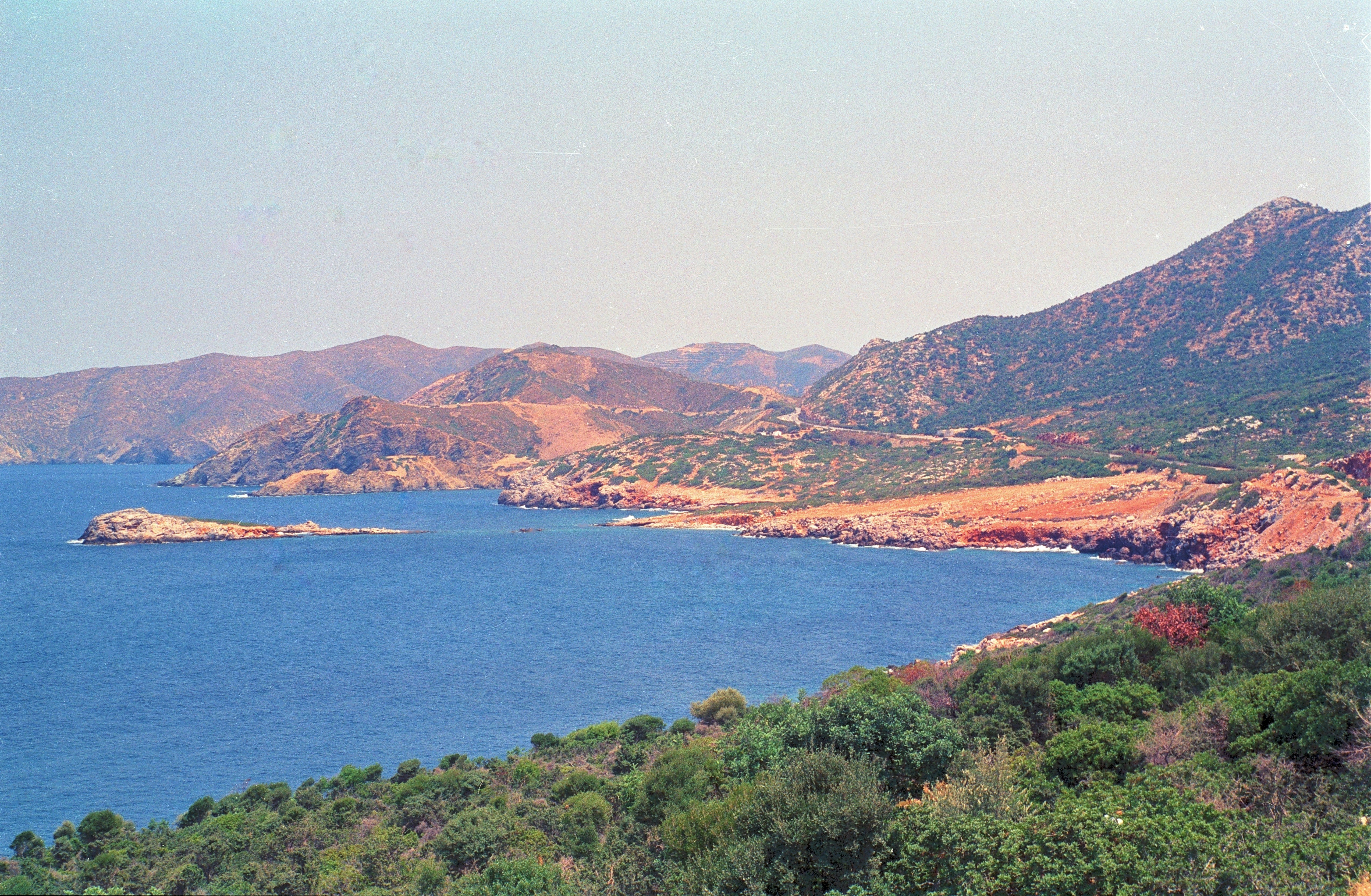Sunlit Riviera Overlook: Coastline Amid Rolling Hills