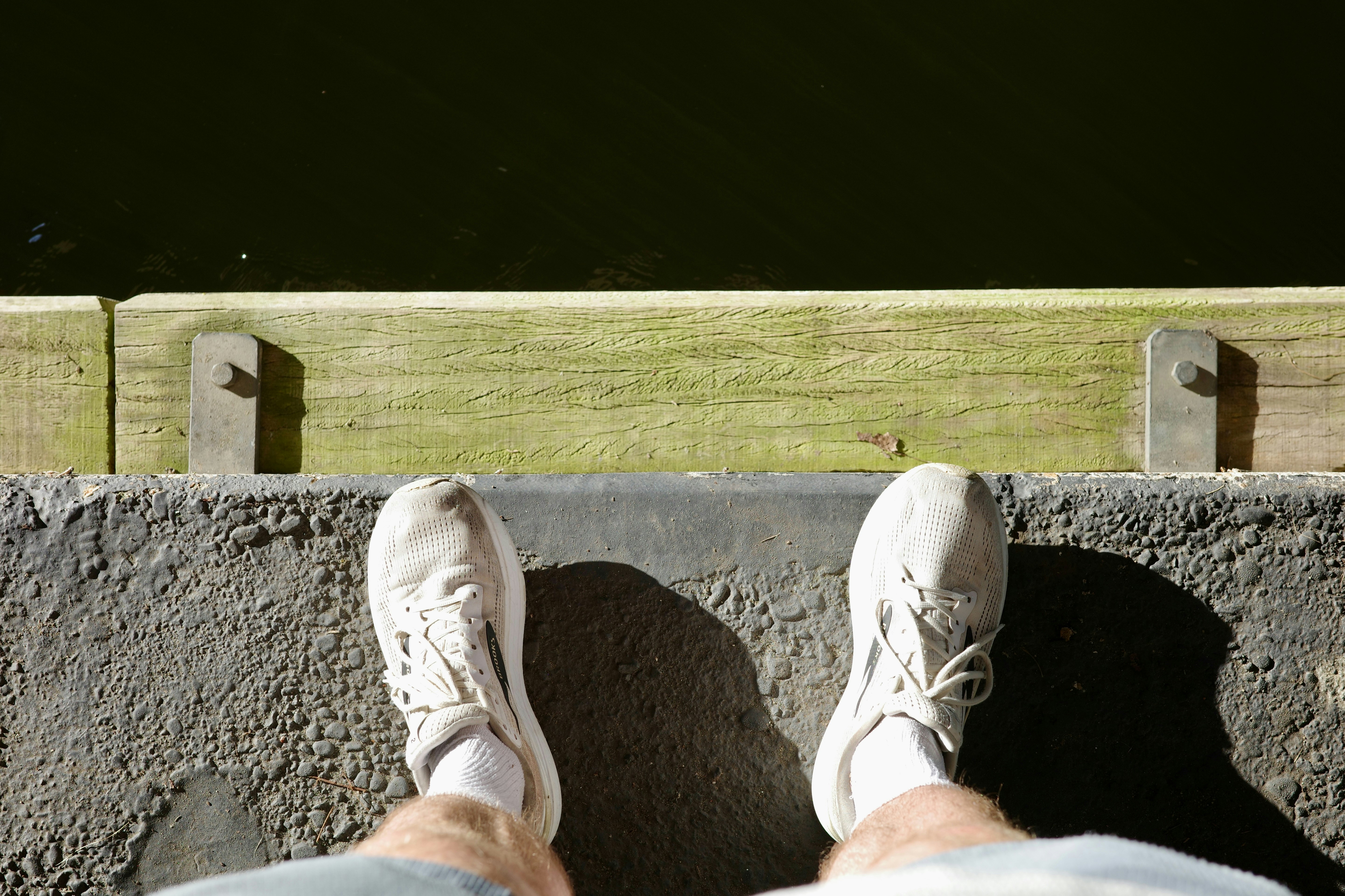 Feet at the Edge: A Narrow View Over the Pier