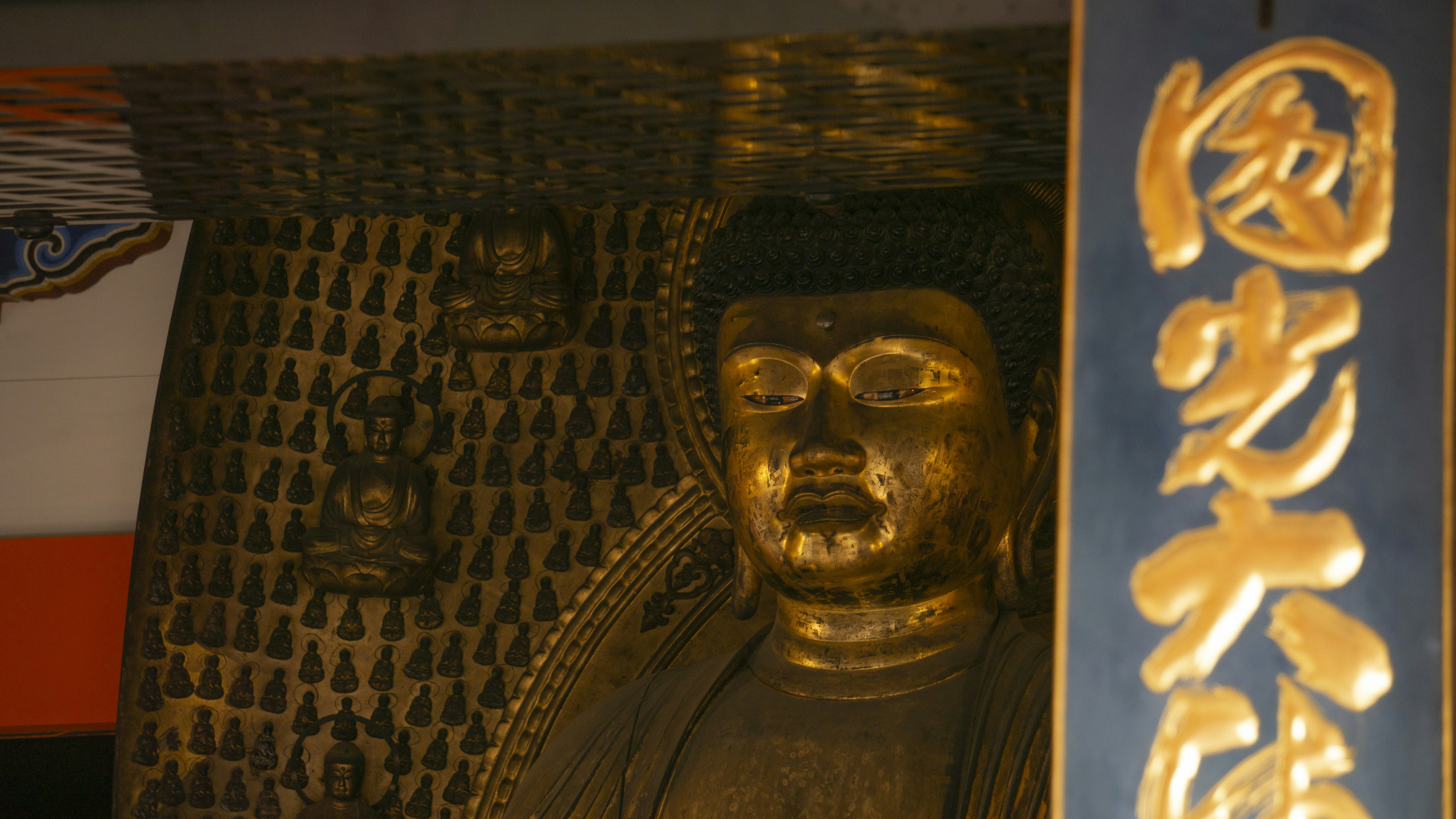 Golden Buddha Amid Lantern-etched Shadows