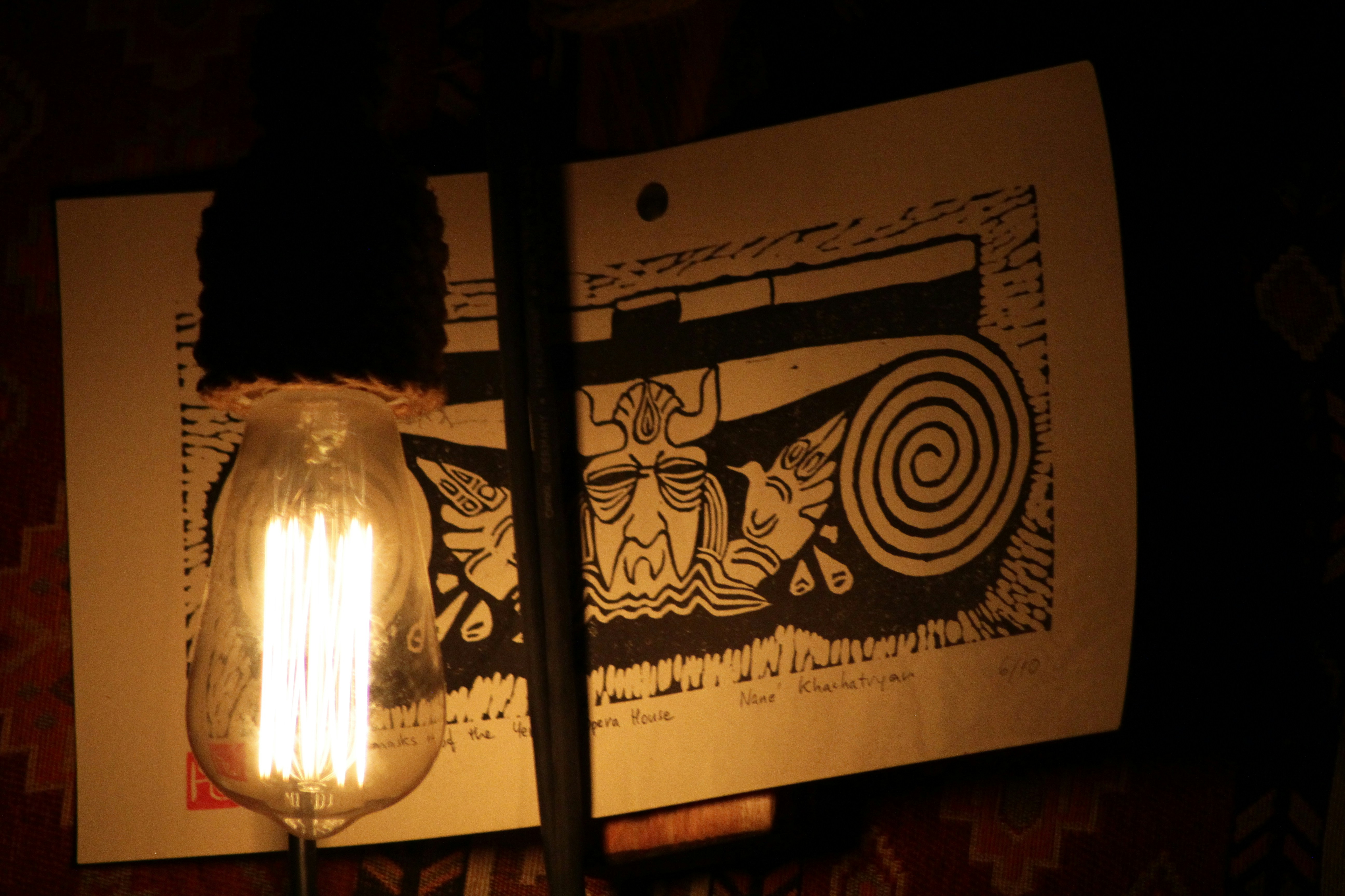 Dim Edison Glow Beside a Surreal Banner