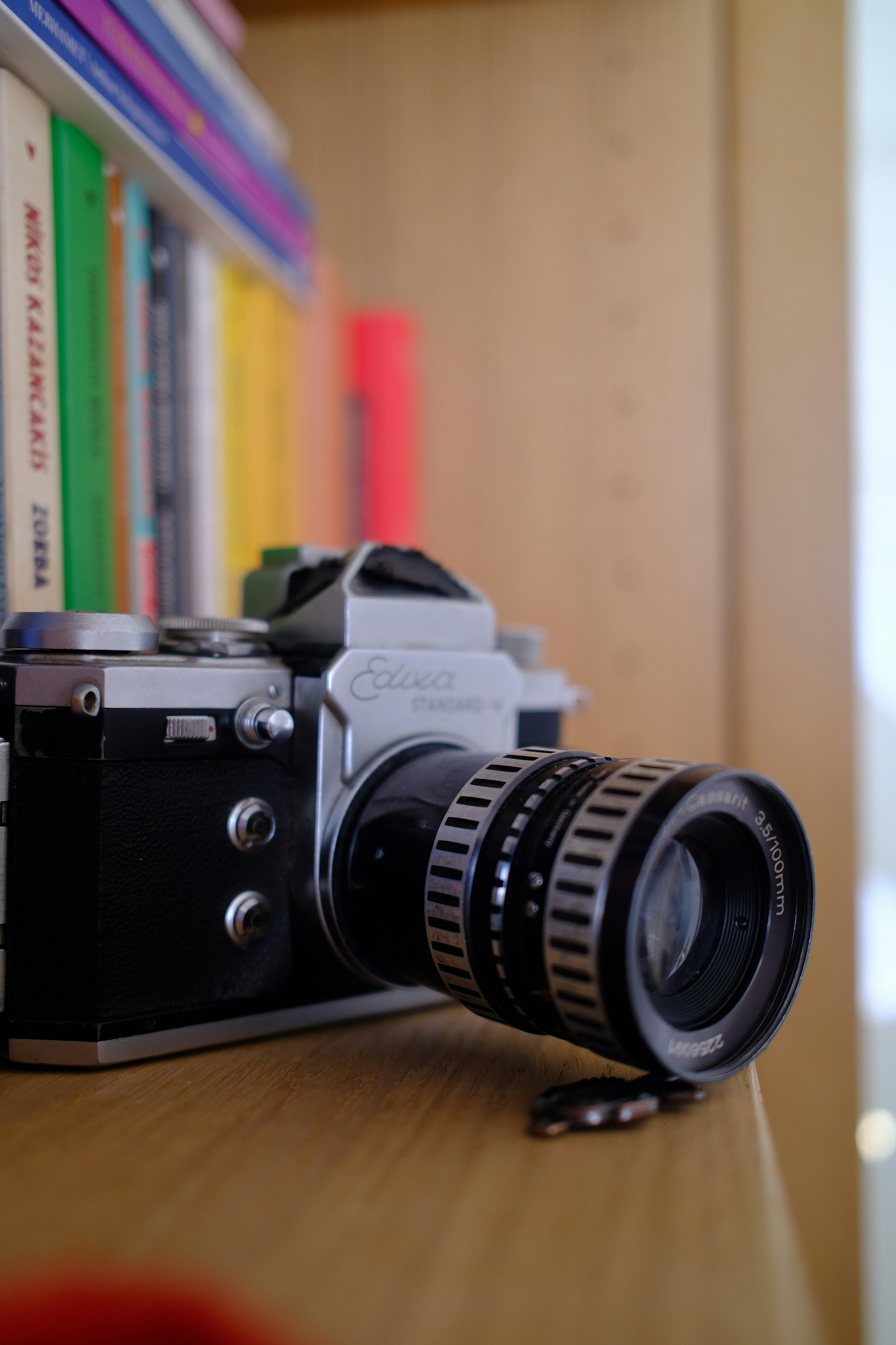 Vintage Lens, Modern Focus: A Classic Camera resting on a Wooden Shelf