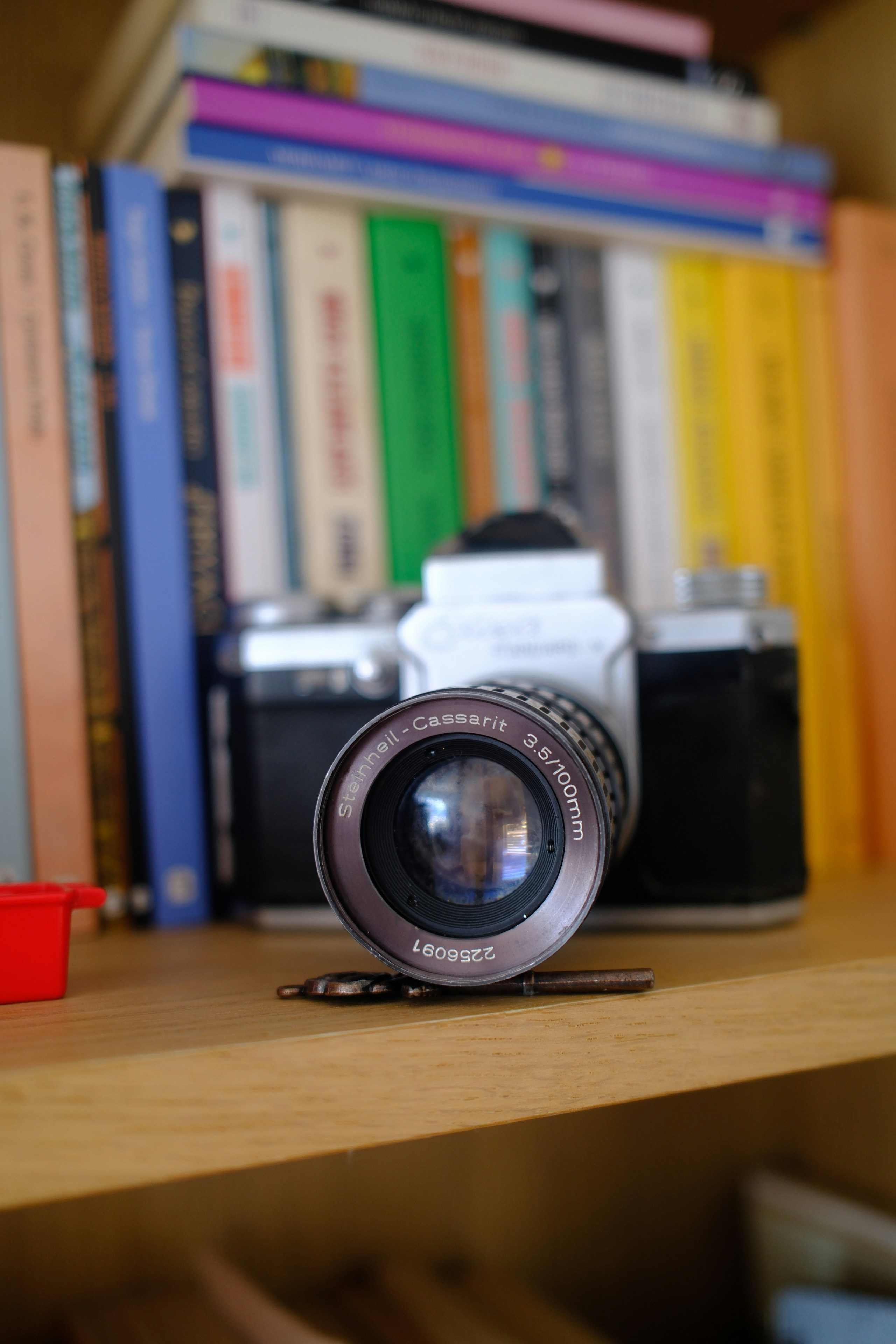 Centered Lens: A vintage 50mm on a bookshelf still life