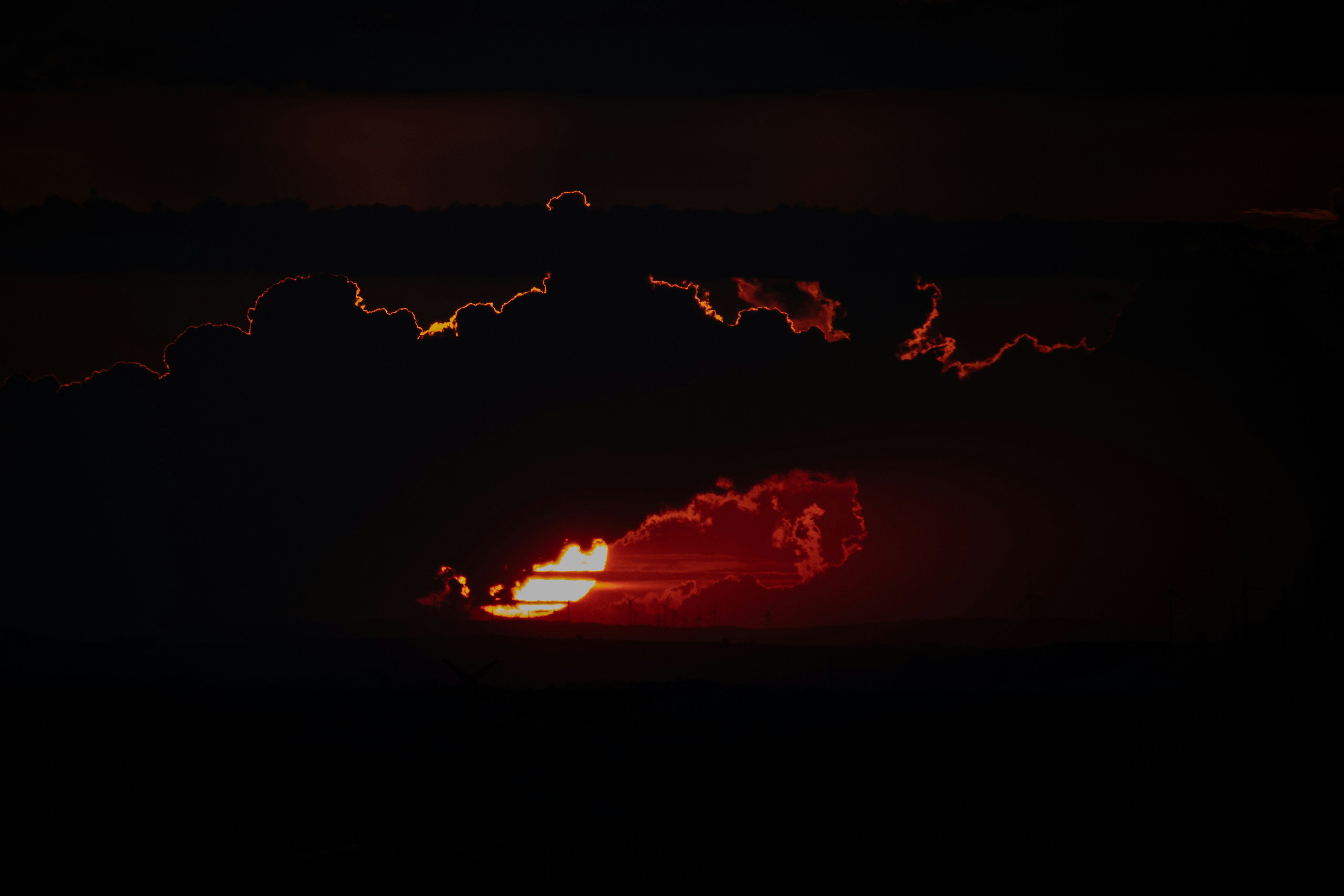 Fiery Gap: Sunset Edge Breaking Through Dark Clouds