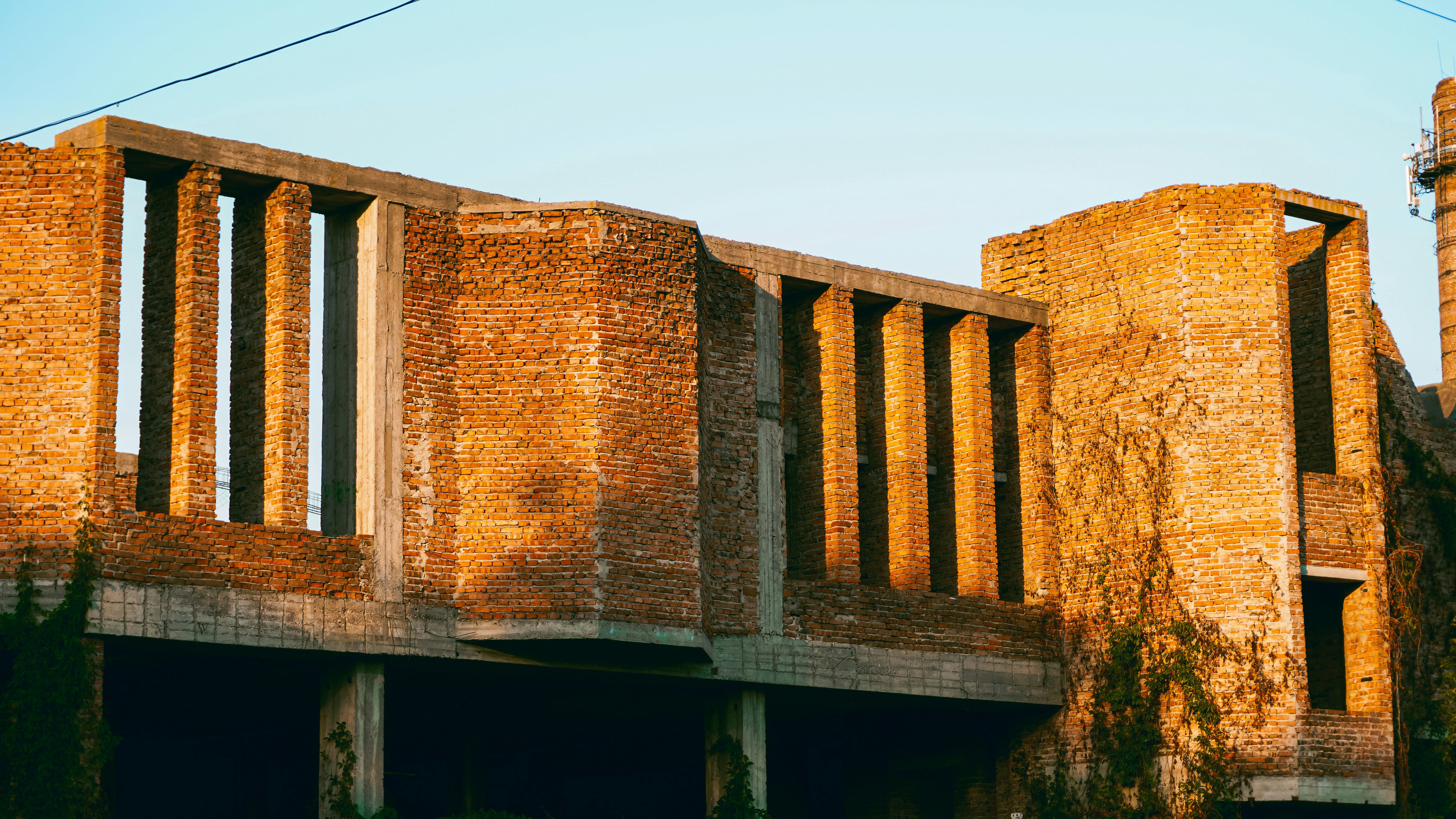 Brickwork Echoes: Ruined Facade Under a Clear Sky