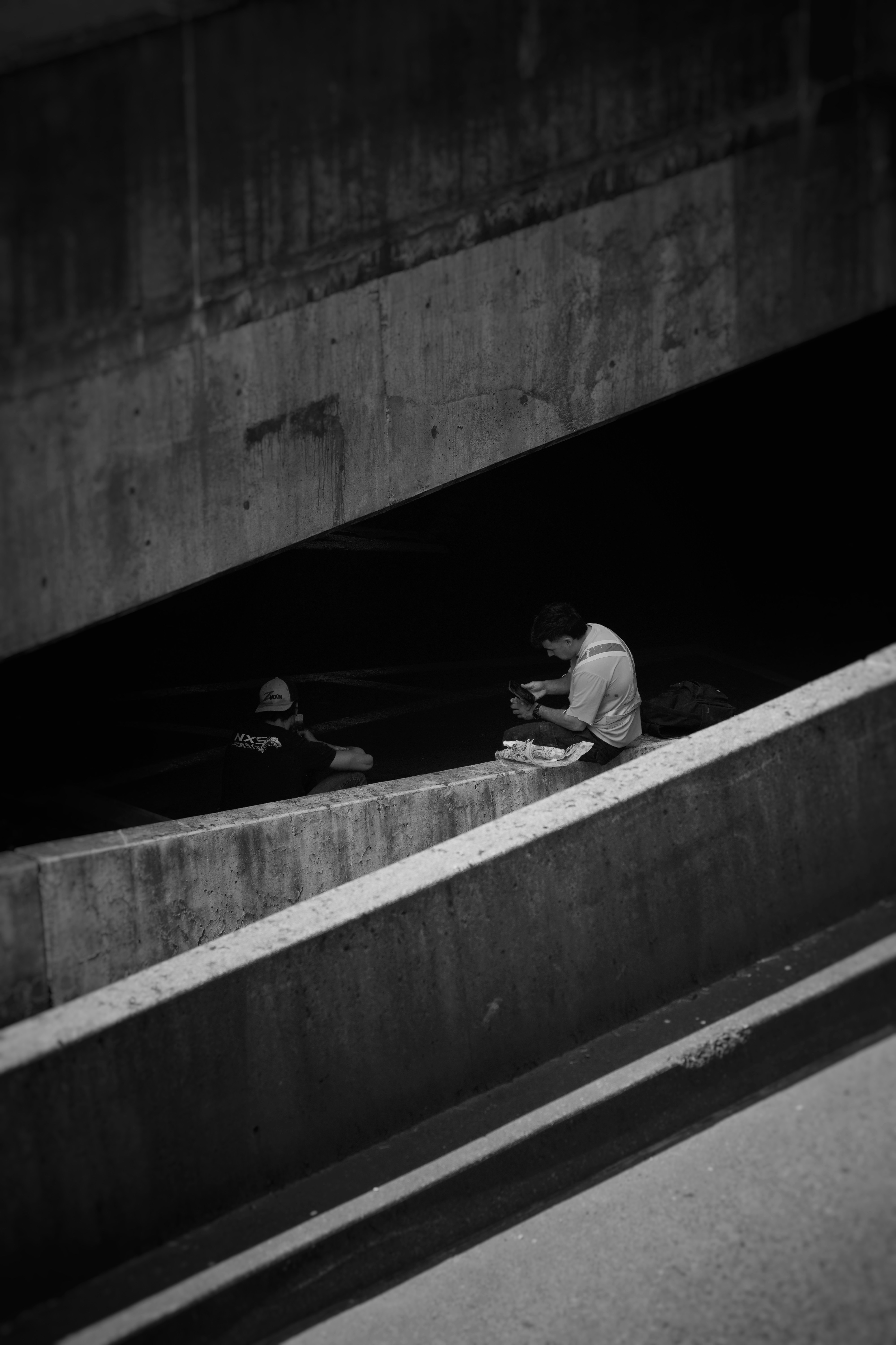 Two Figures at the Edge: Quiet Ground Between Concrete Ramps
