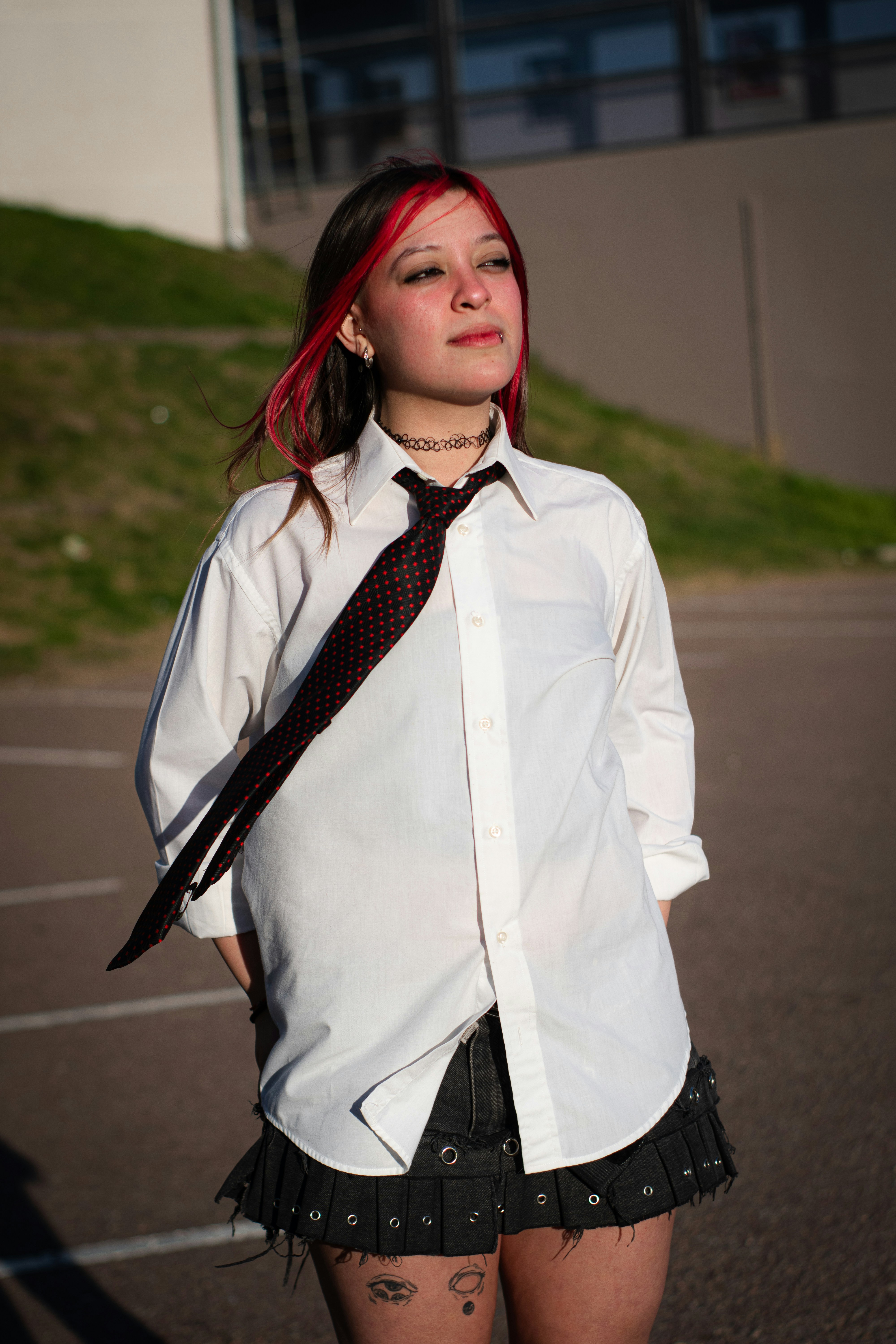 Red-Lined Standout: A Casual Rebel Poses in Schoolyard Shade