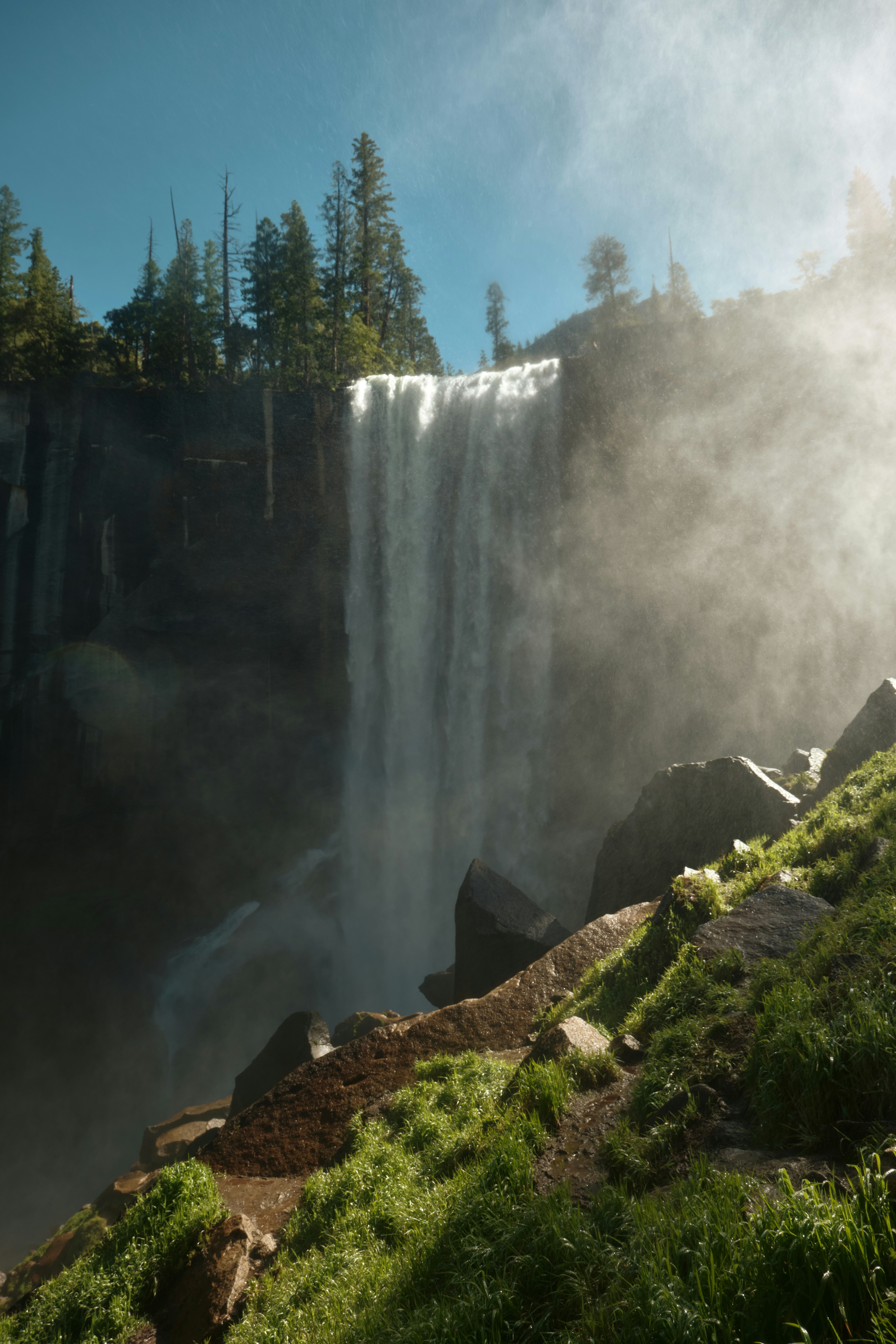 Mist and Plunge: A Sunlit Cascade from the Cliffside Edge