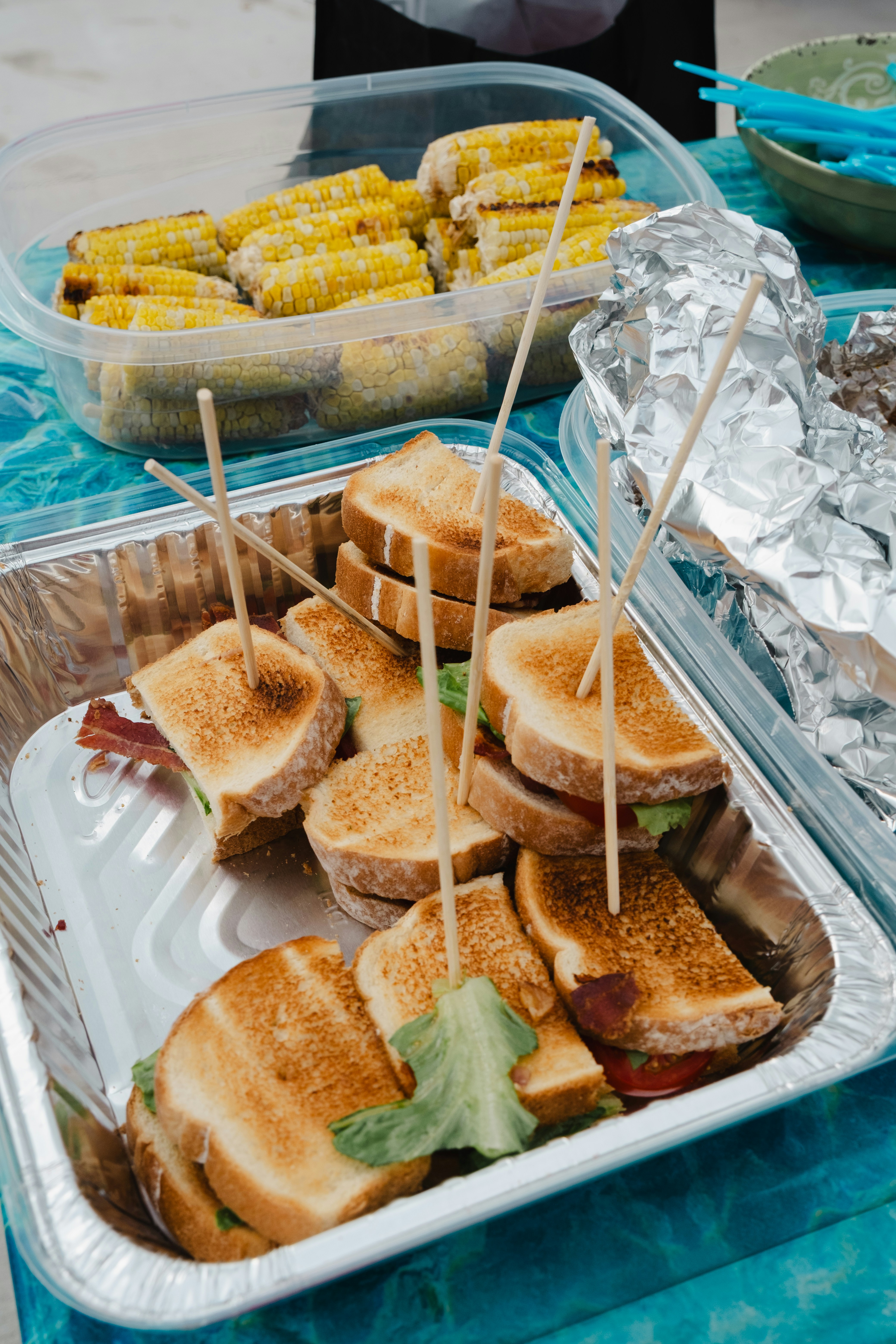 Skewered Sandwiches and Grilled Corn at a Casual Food Tray