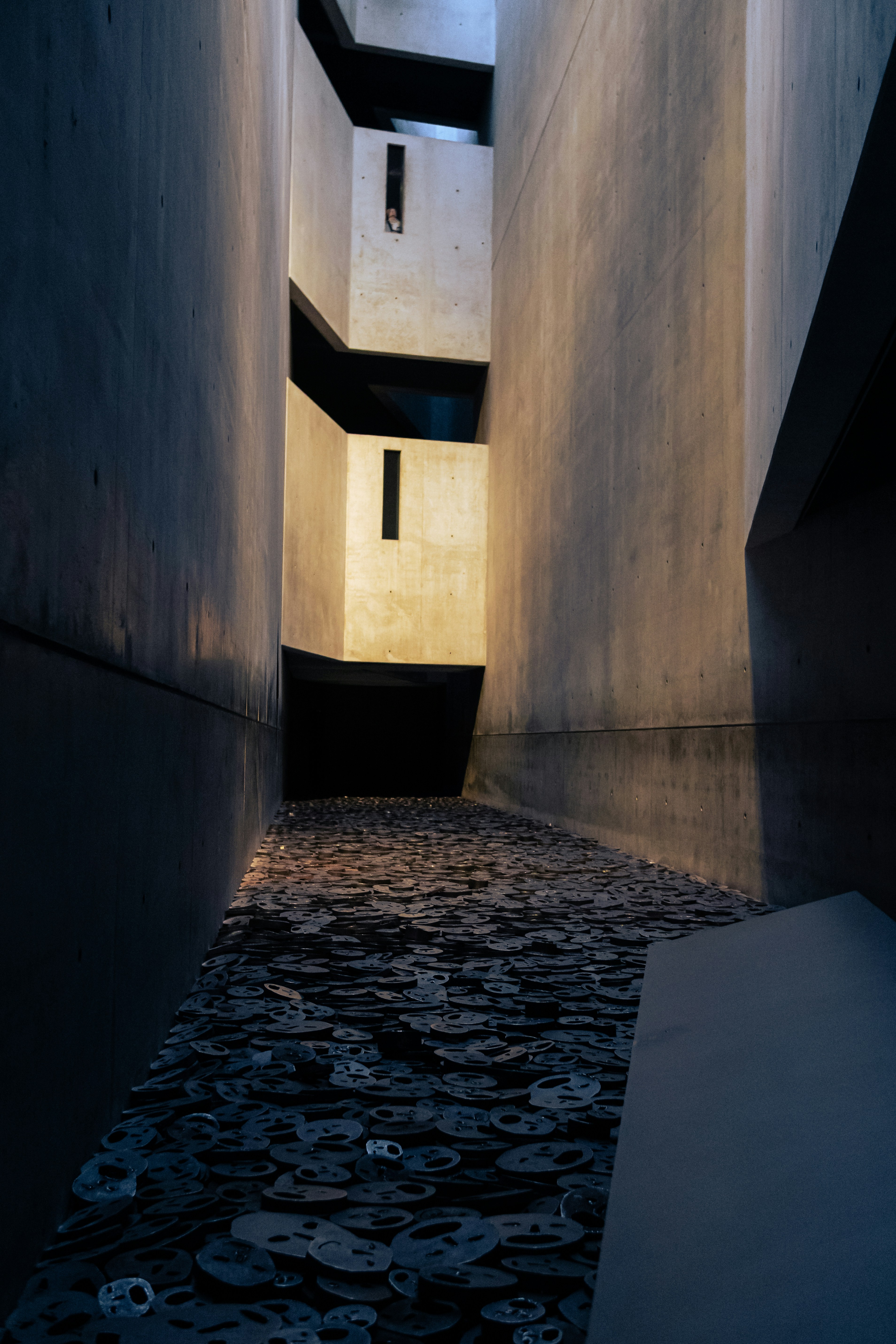 Concrete Conduit: Light Strikes Inside a Narrow Atrium