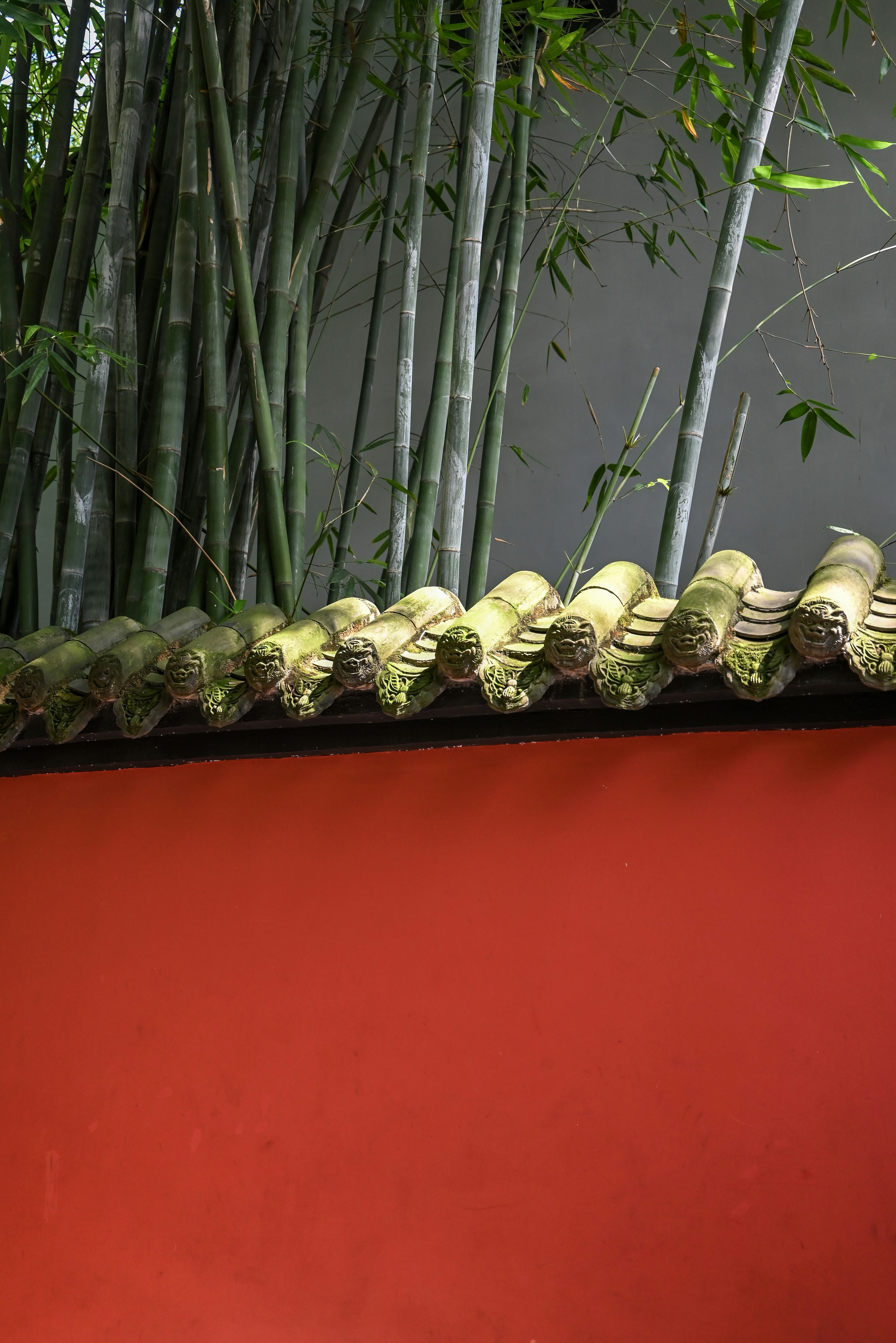 Rust and Bamboo Roof: A Quiet Boundary Between Wall and Garden