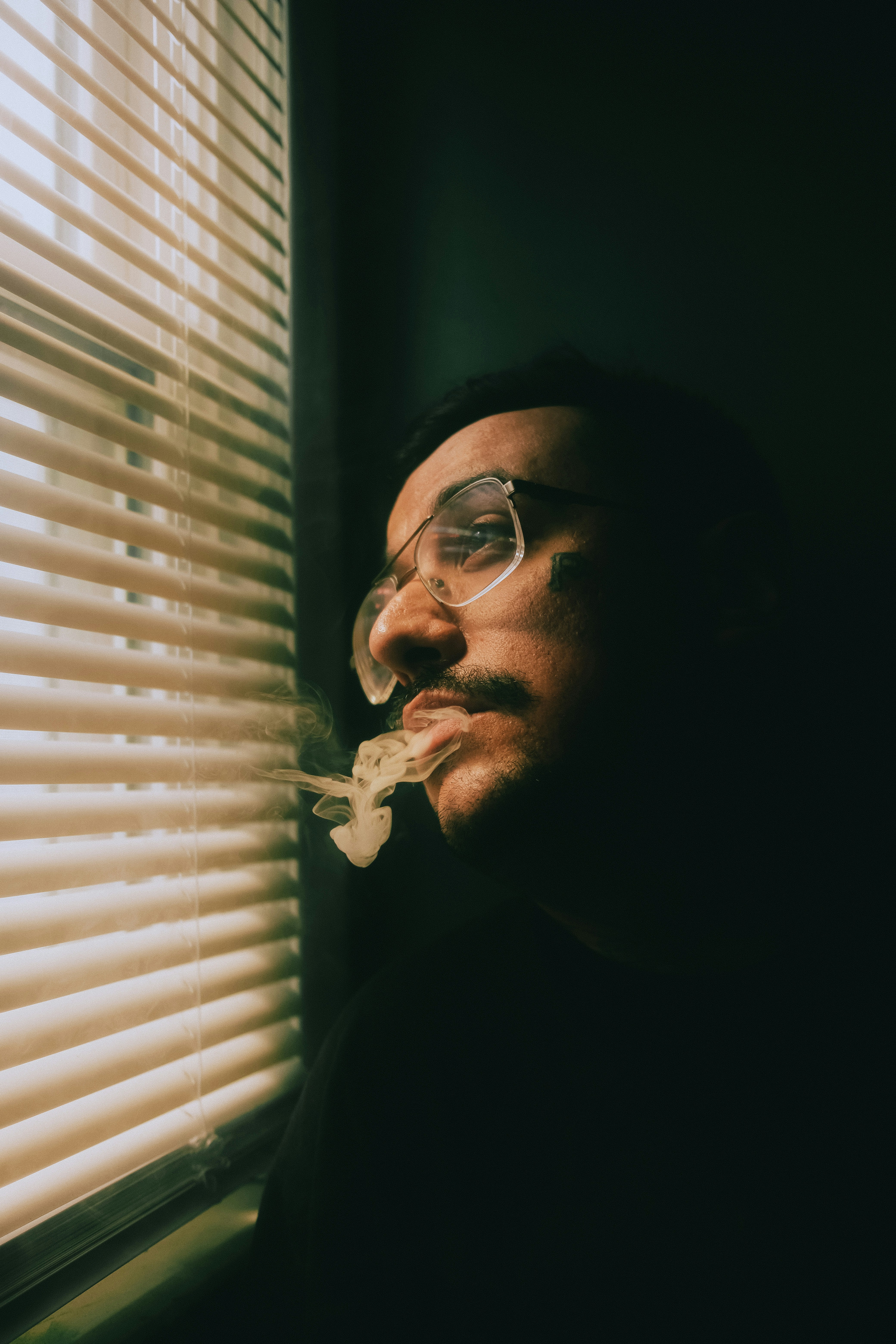 Smoke in the Spotlight: A Quiet Portrait by Window Light
