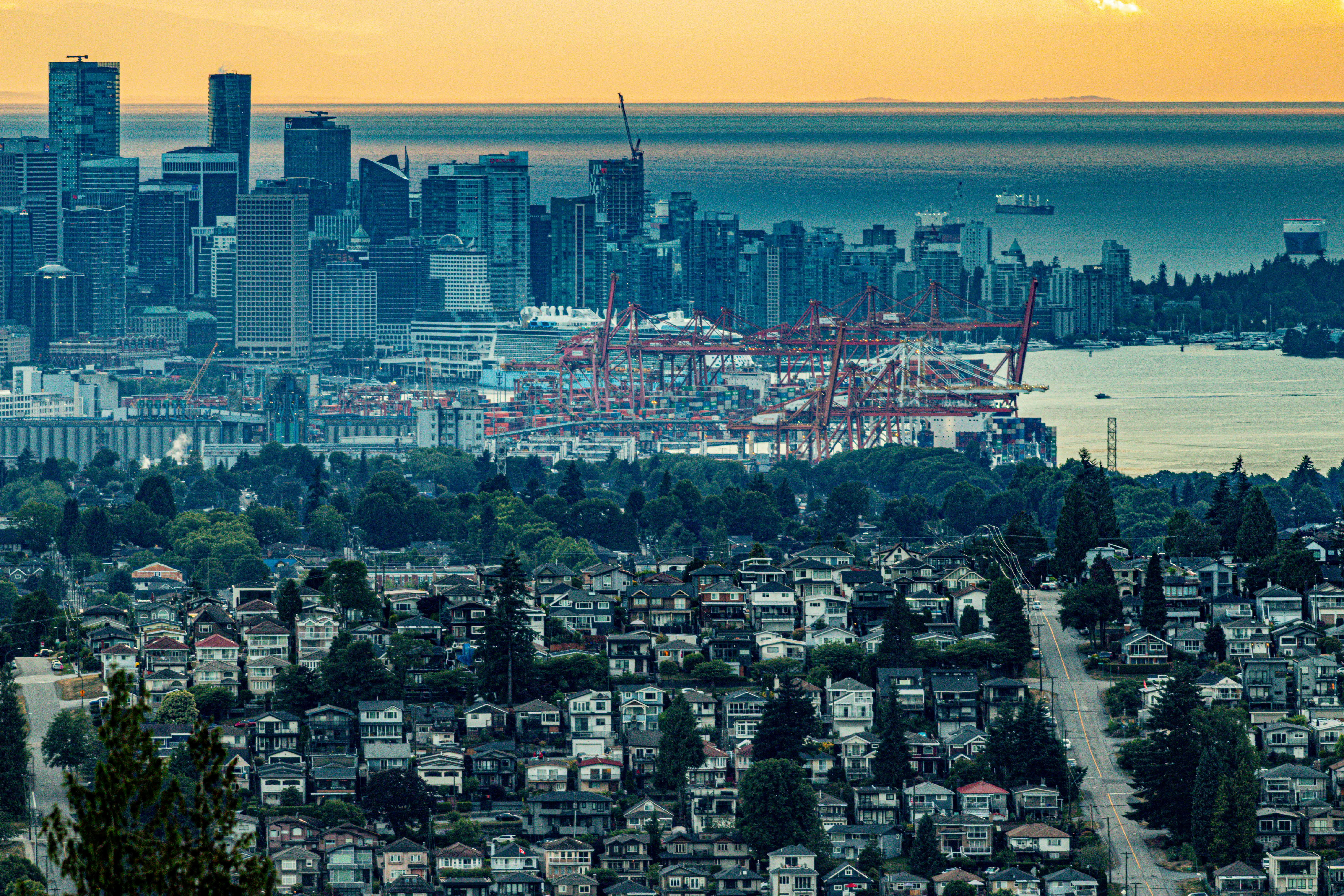 Dockyard Gaze: Cityscape Beyond the Hills at Dusk