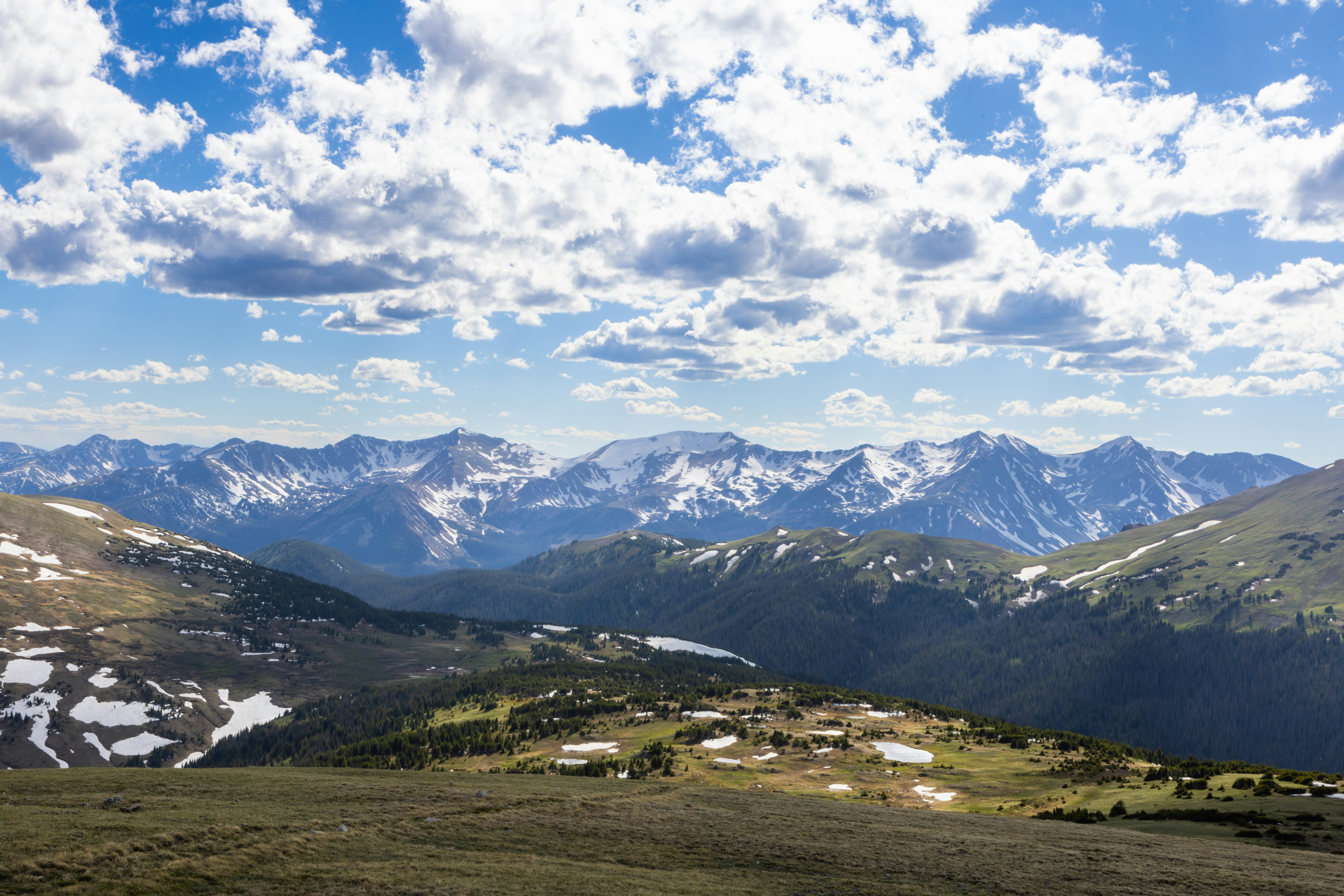 Crescent Ridge: Snow-kissed Alps Under a Vault of Clouds