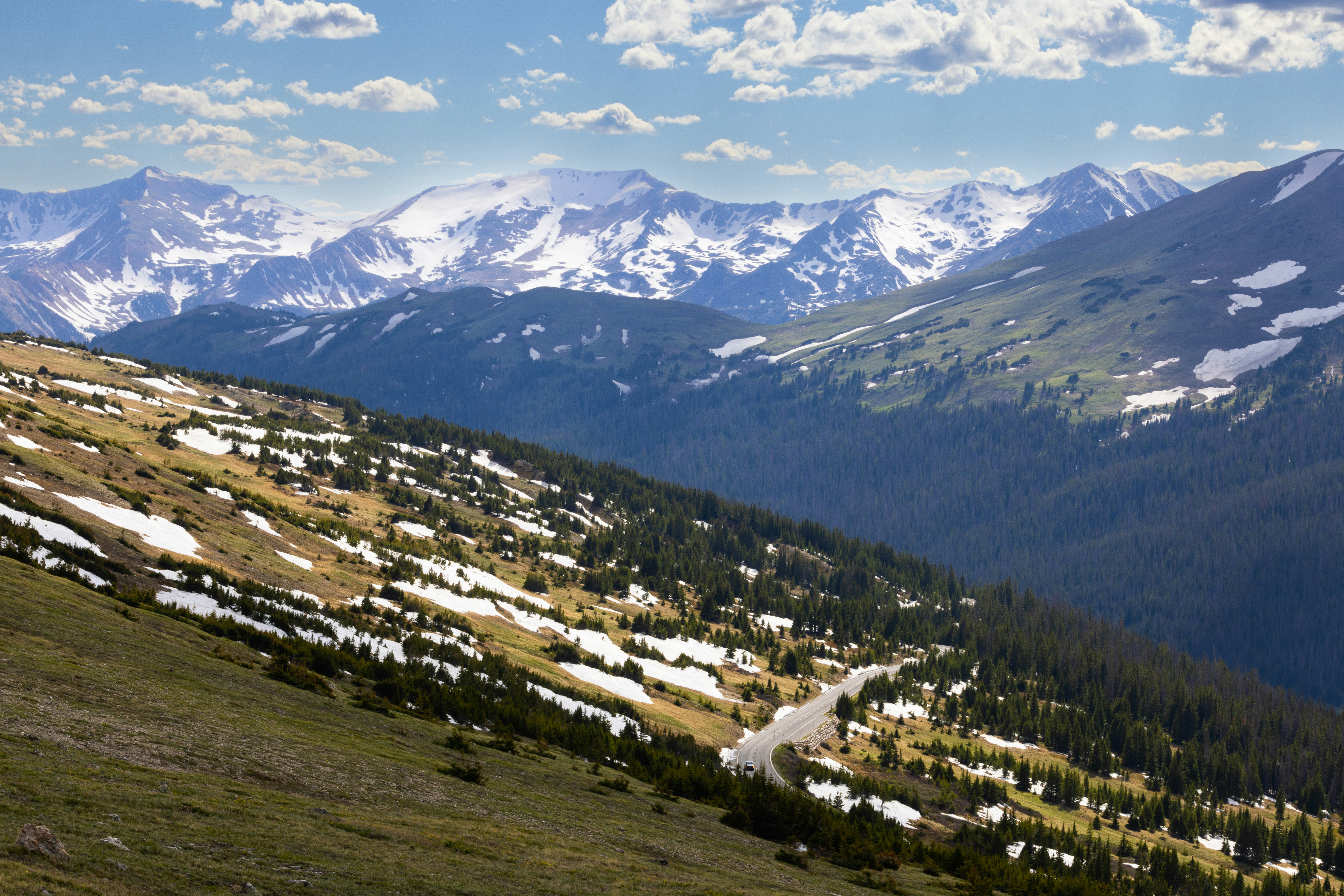 Snow-kissed ridgeline winding through sunlit alpine slopes