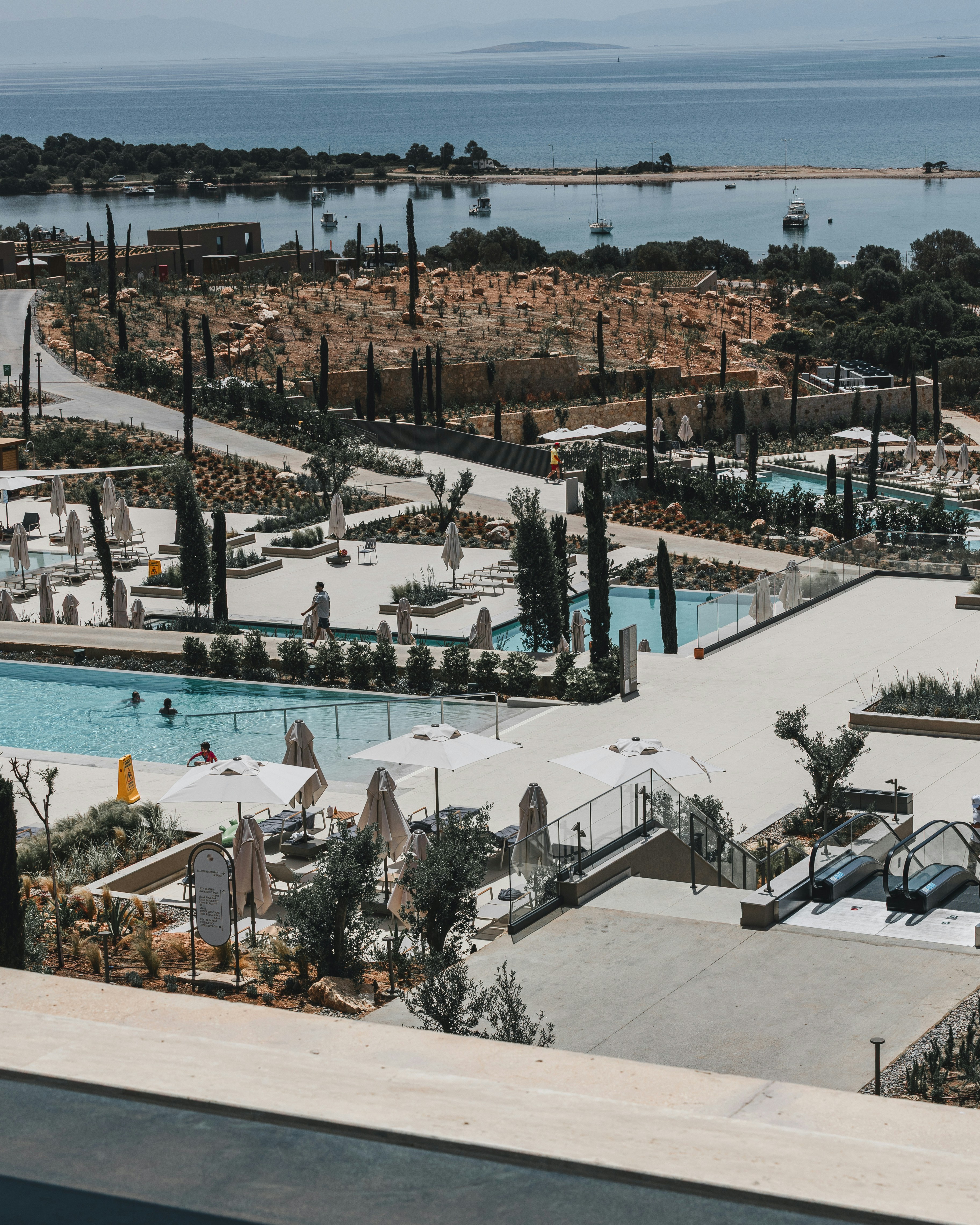 Terraced resort pools overlook a tranquil harbor